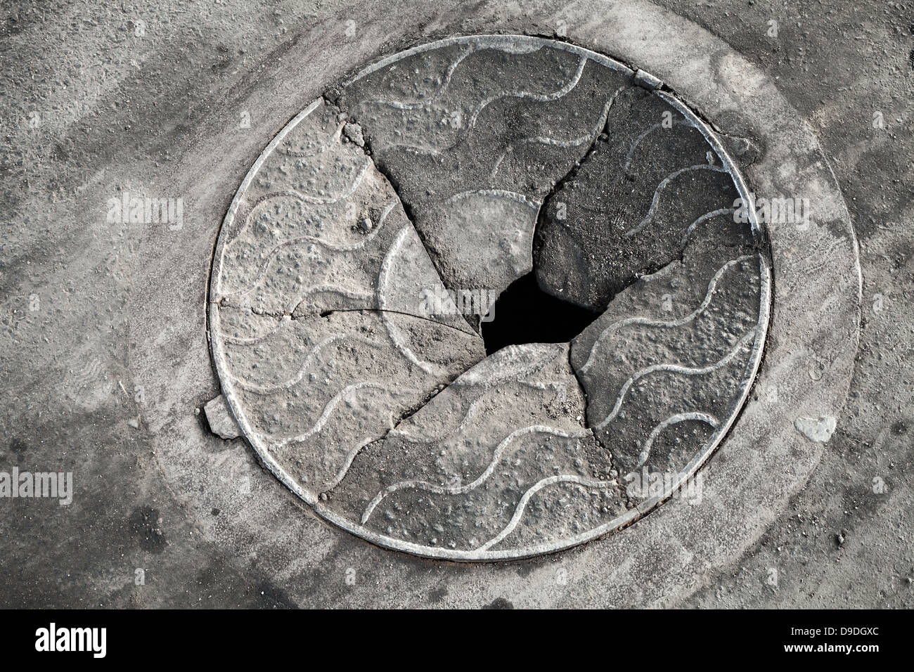 Old broken manhole cover on the asphalt road Stock Photo - Alamy