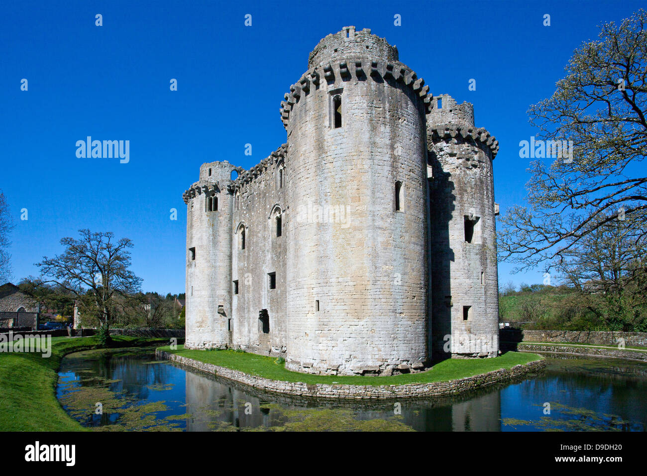 The ruins of Nunney Castle surrounded by its moat, built in the 1370s ...