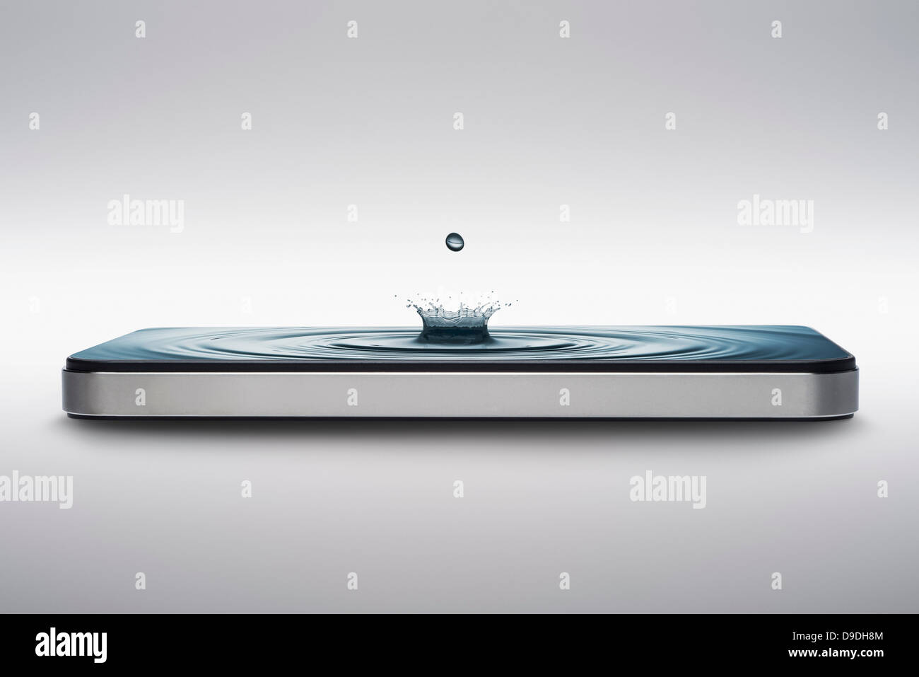 Smart phone with water crown droplet and ripple on screen Stock Photo ...
