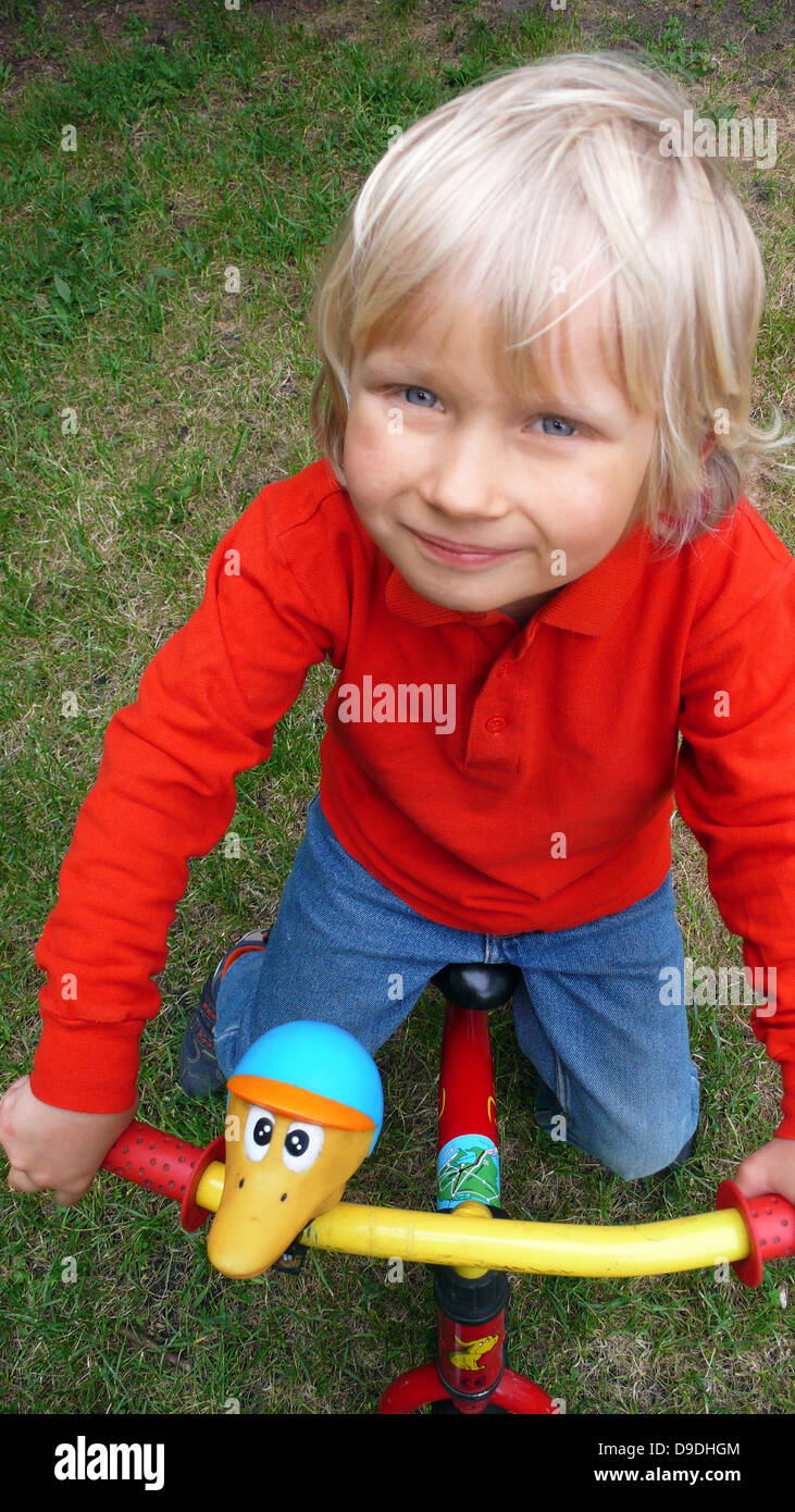 Boy with red bike Stock Photo - Alamy