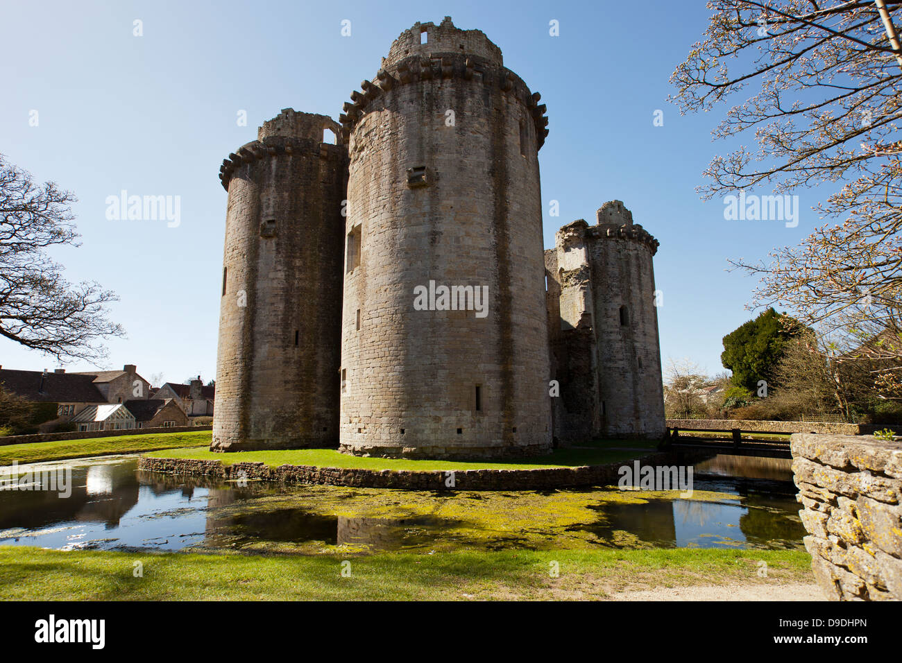 The ruins of Nunney Castle surrounded by its moat, built in the 1370s ...