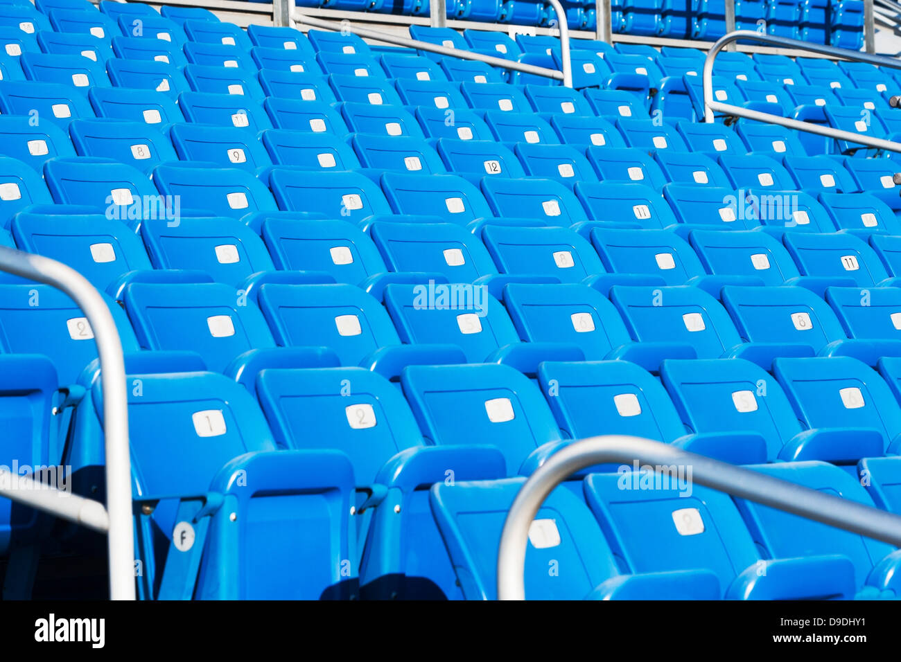 Empty blue seating in sports stadium Stock Photo - Alamy