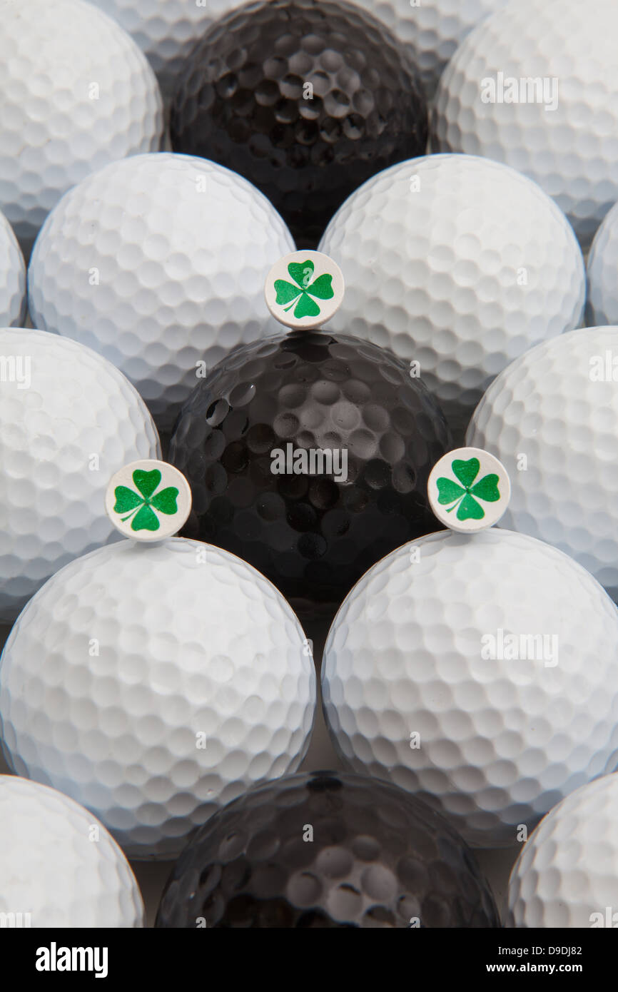 Different golf balls and wooden tees with four leaf clovers Stock Photo ...