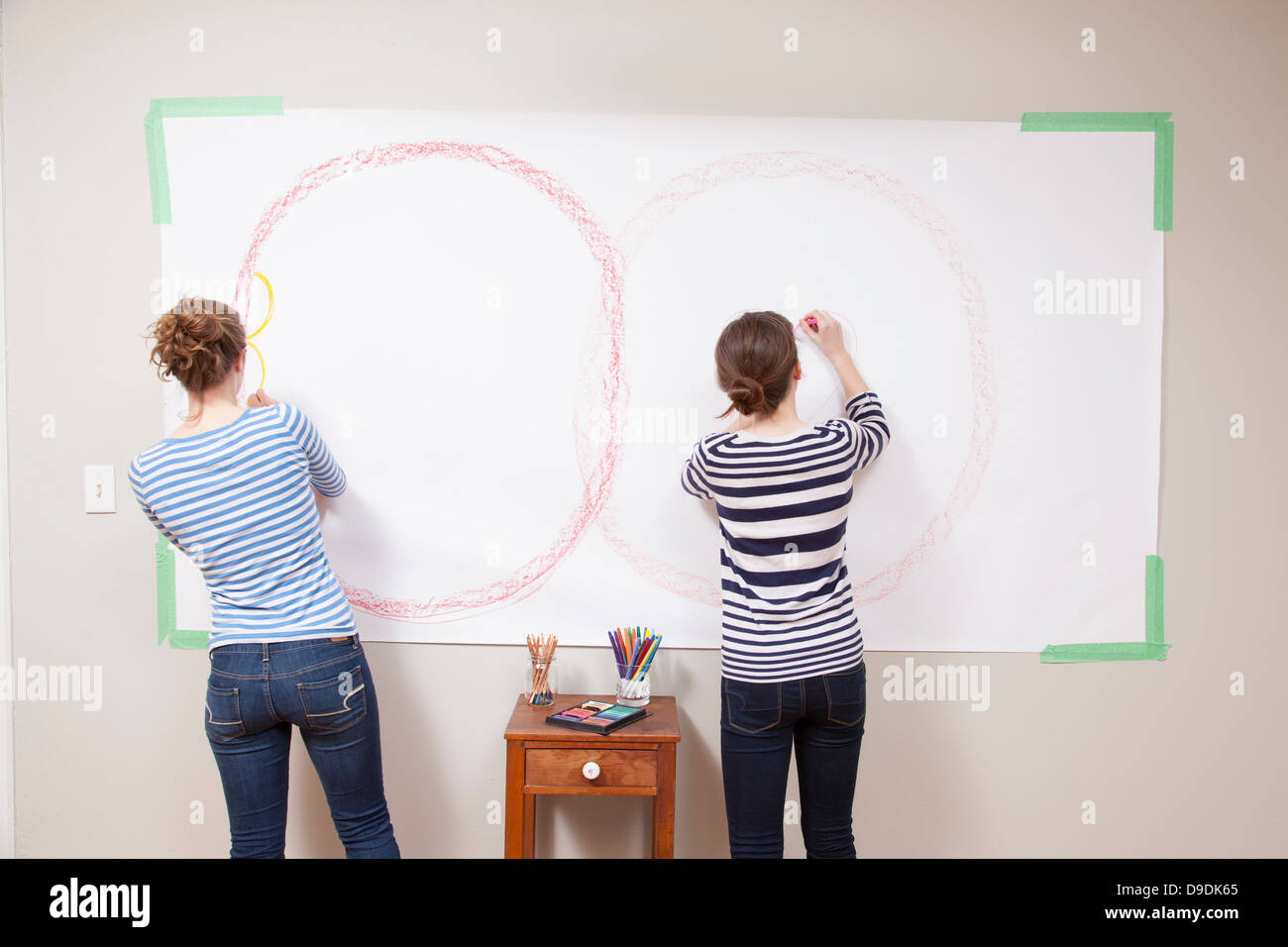 Girls drawing on wall Stock Photo - Alamy