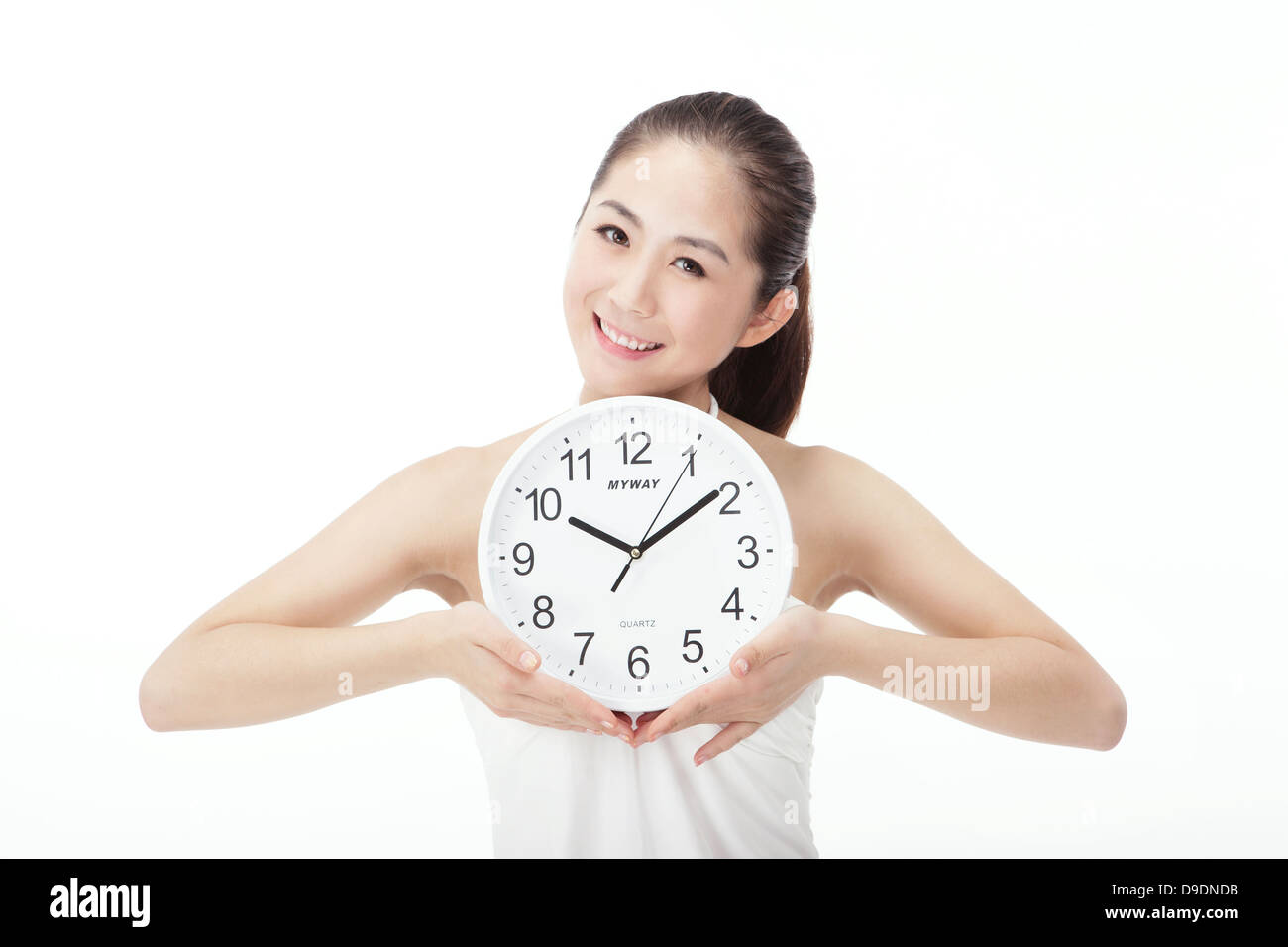 Young indian woman holding clock hi-res stock photography and images ...