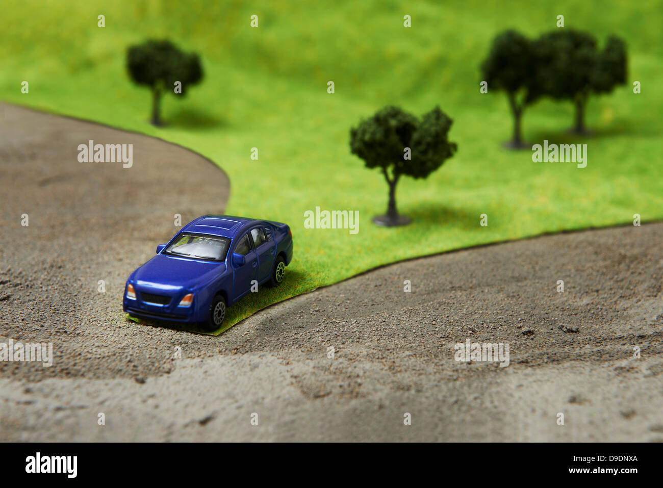 Toy car on model landscape Stock Photo - Alamy