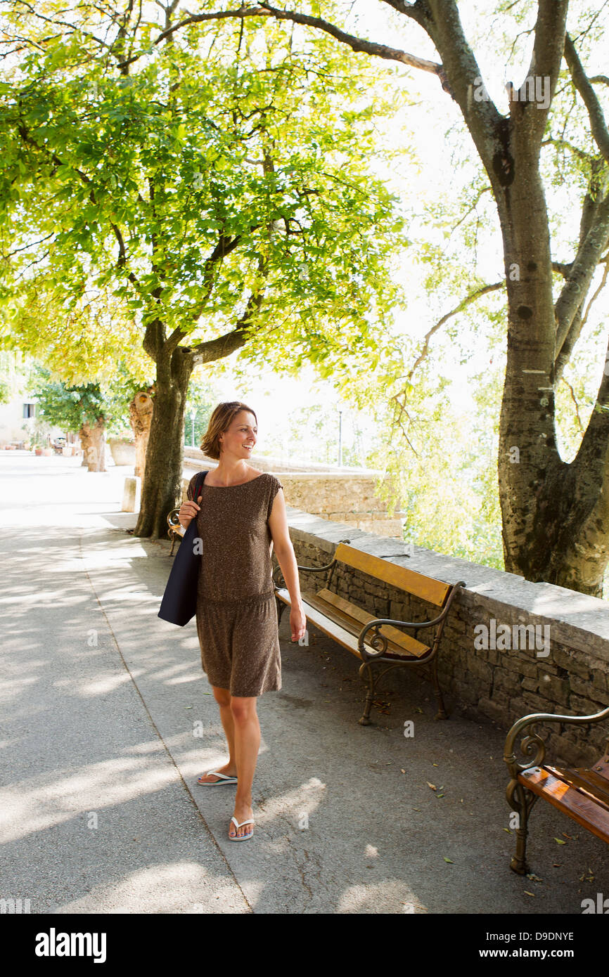 Woman on path with trees Stock Photo - Alamy