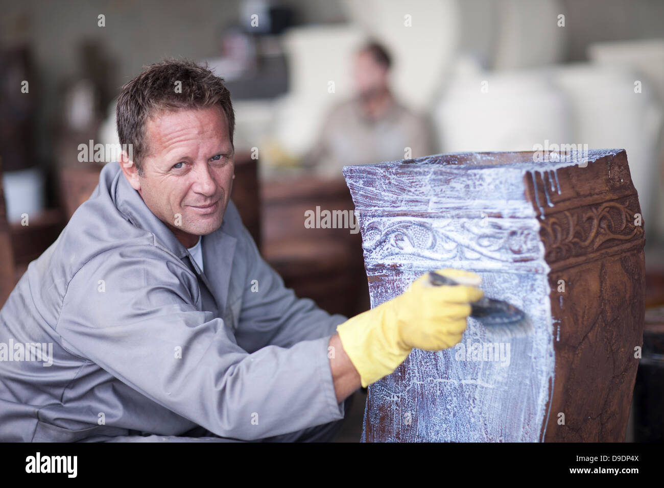 Painting and staining process in pottery factory Stock Photo - Alamy