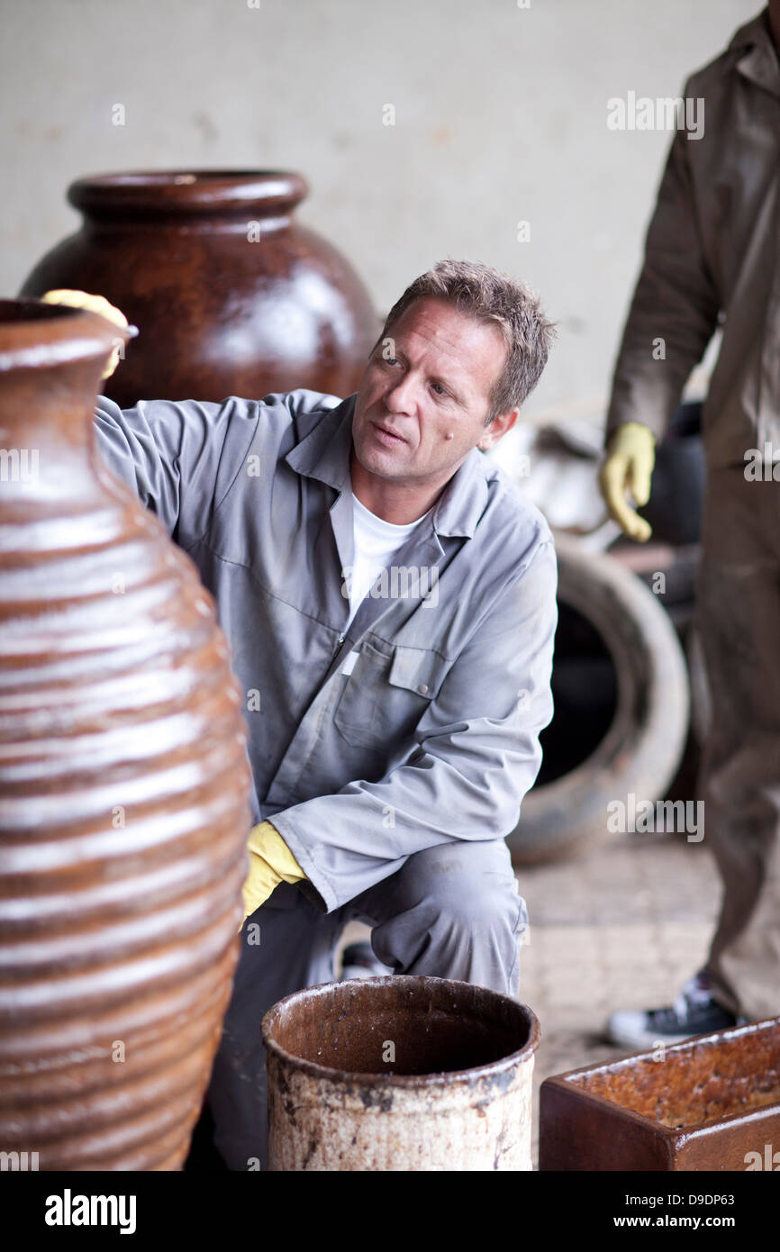 Painting and staining process in pottery factory Stock Photo - Alamy