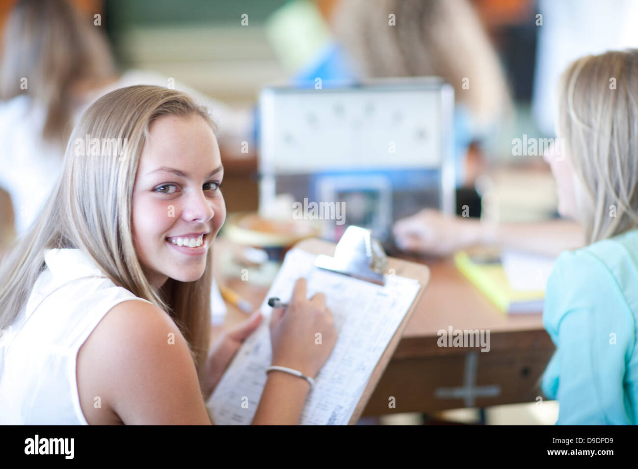 Girl turning around to look at the camera Stock Photo - Alamy