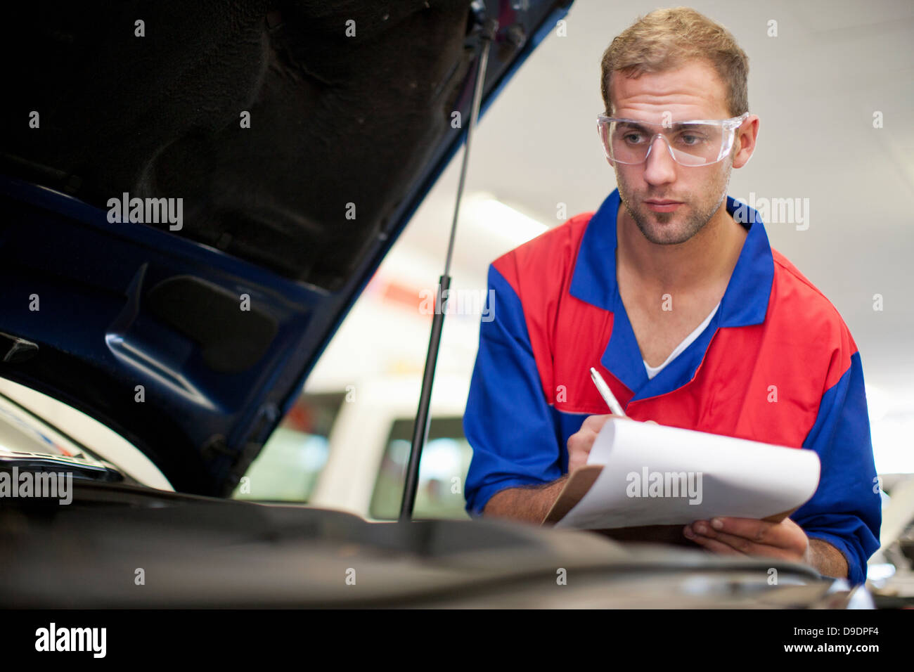 Car mechanic at work in service bay Stock Photo - Alamy