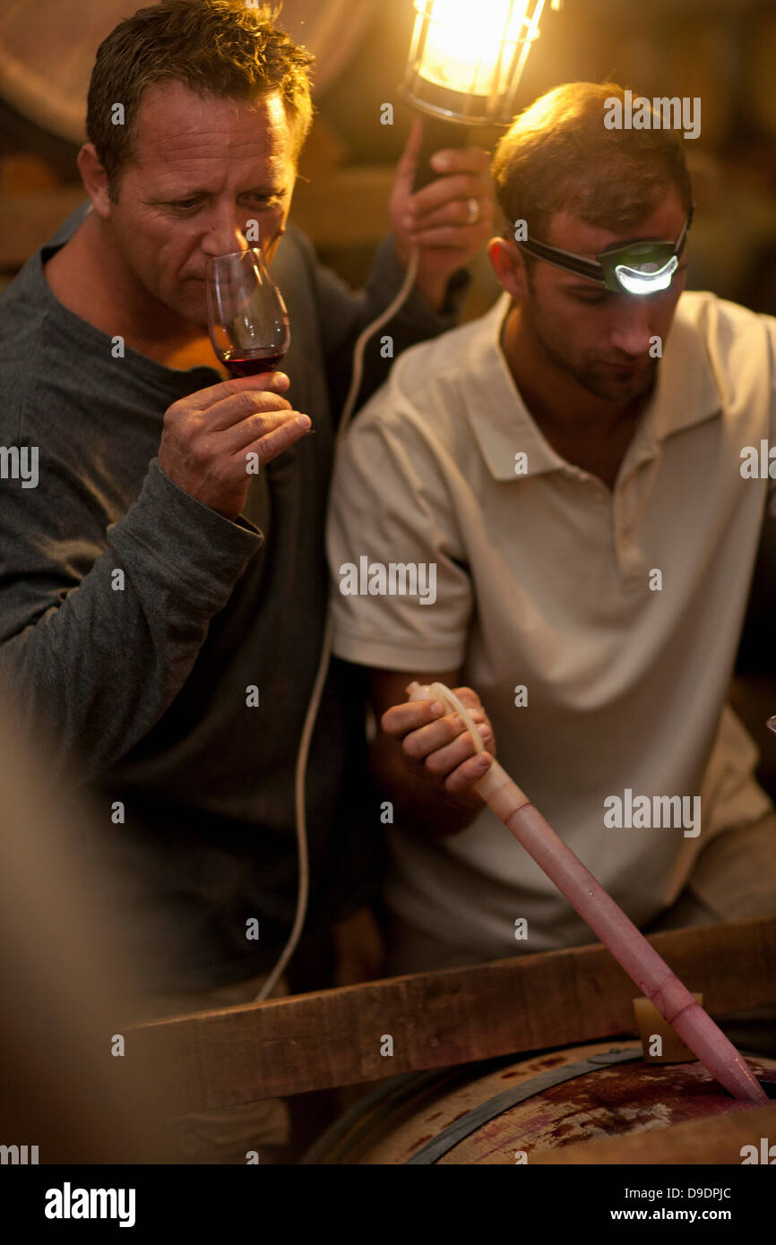 Sampling wine in barrels Stock Photo - Alamy