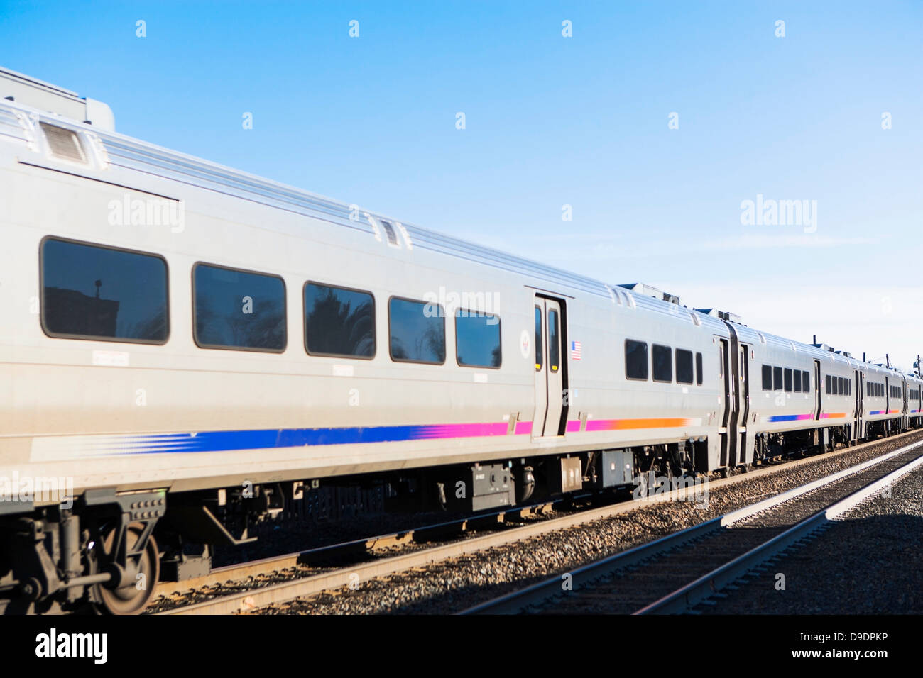 Passenger train on railroad Stock Photo - Alamy