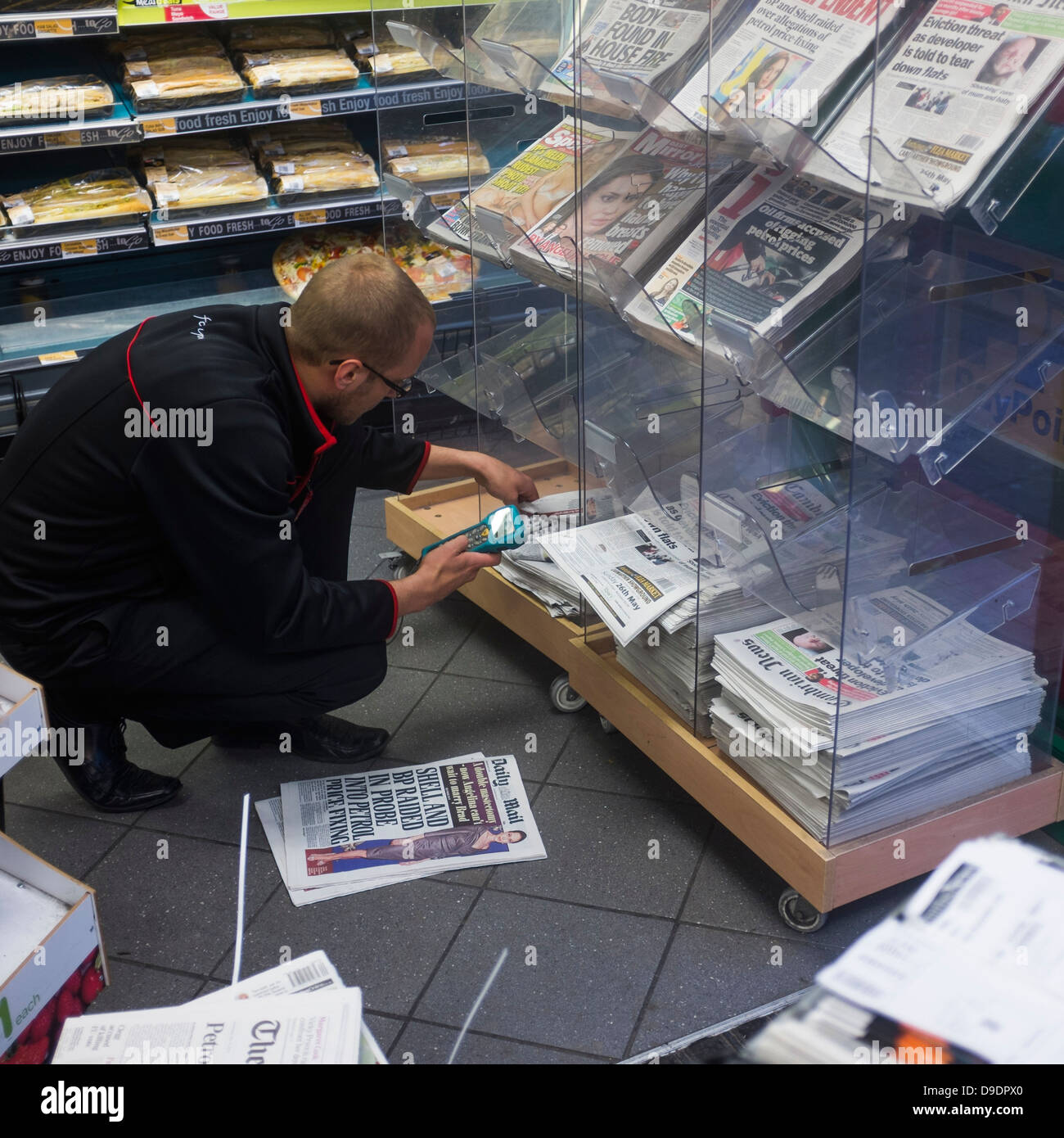 Delivery of daily UK newspapers being digitally scanned before going on ...