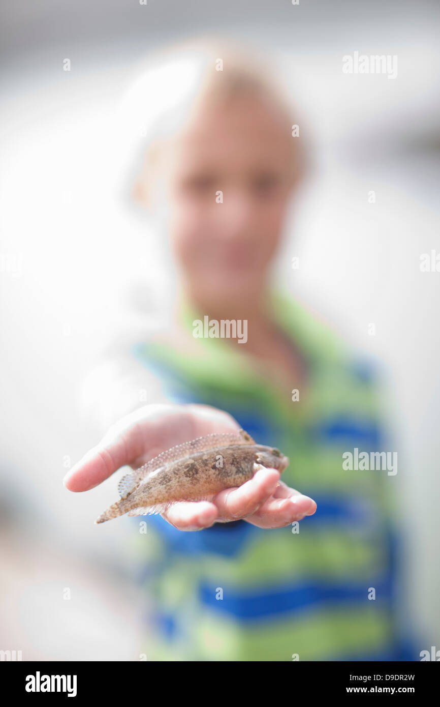 Young boy with small fish in hand Stock Photo - Alamy