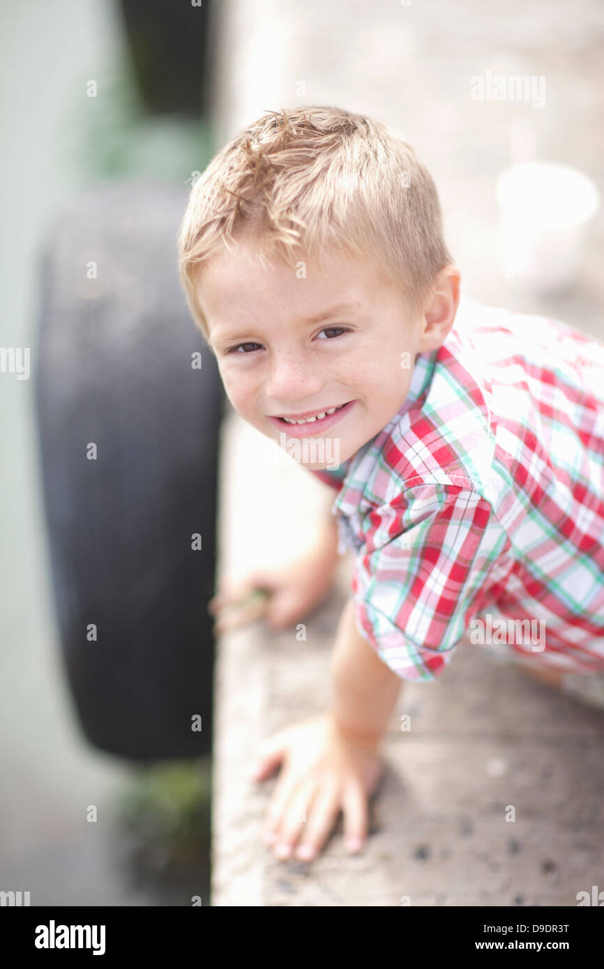 Boy leaning on wall hi-res stock photography and images - Alamy