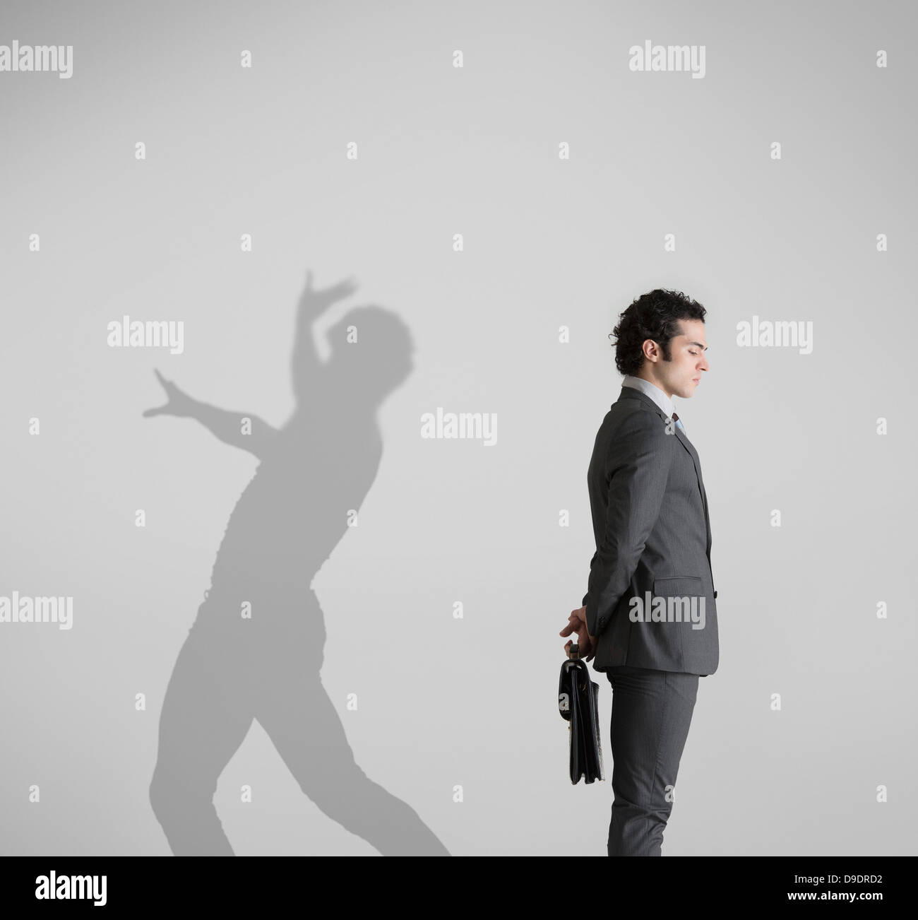 Shadow man holding briefcase hi-res stock photography and images - Alamy