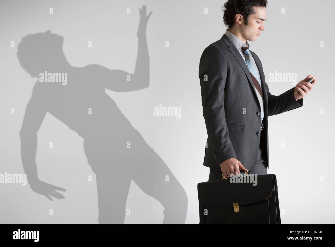 Shadow man holding briefcase hi-res stock photography and images - Alamy