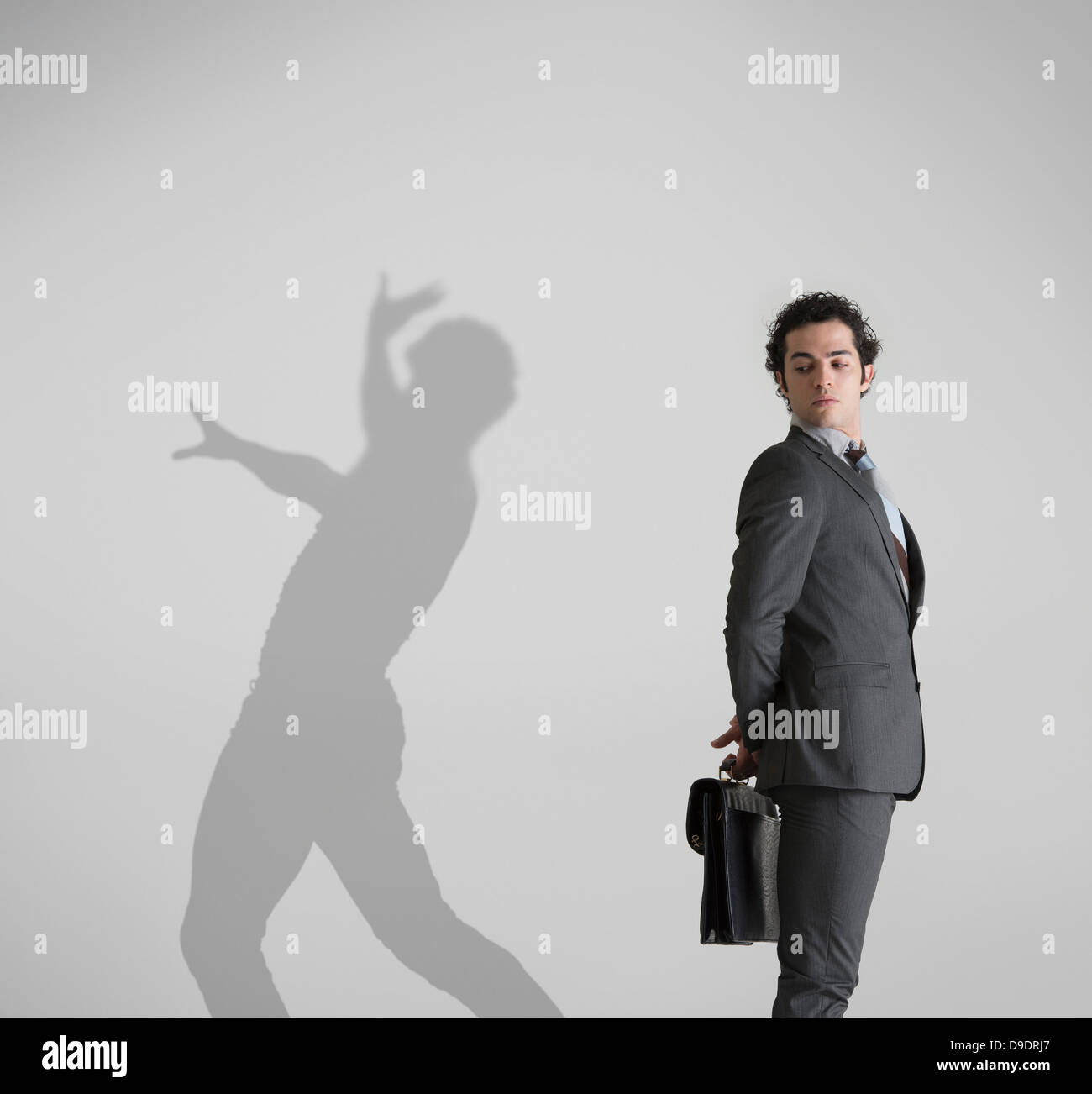 Shadow man holding briefcase hi-res stock photography and images - Alamy