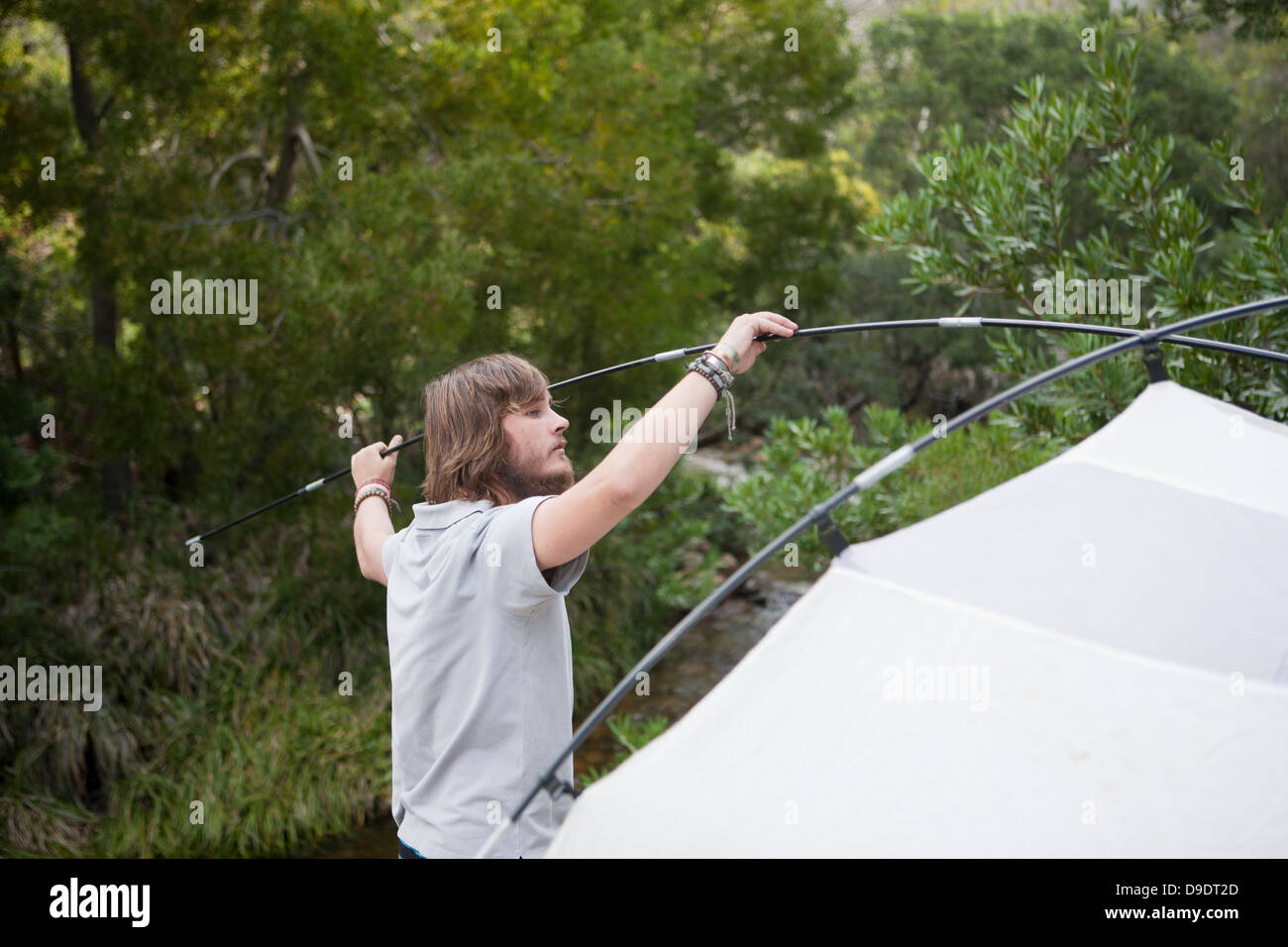 Portrait of young man setting up tent Stock Photo - Alamy Portrait of young man setting up tent Stock Photo - Alamy