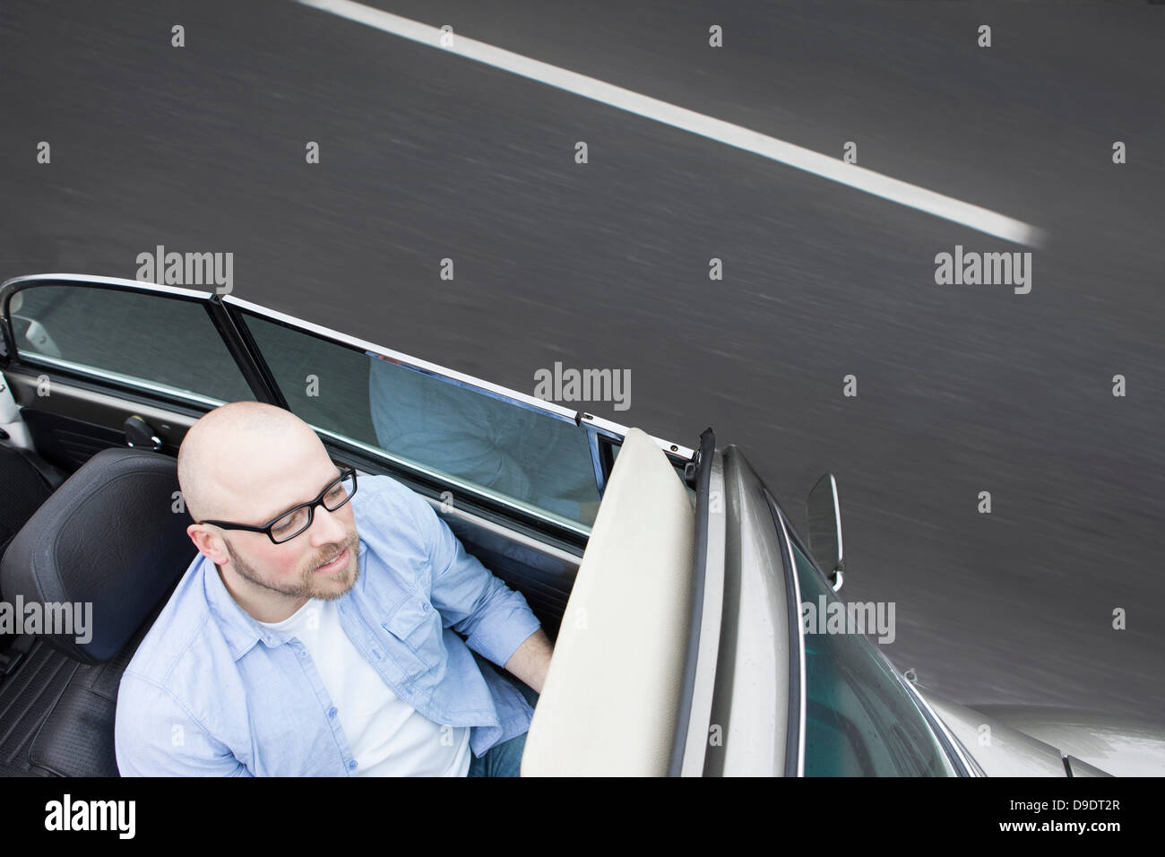 Young man driving convertible car Stock Photo - Alamy