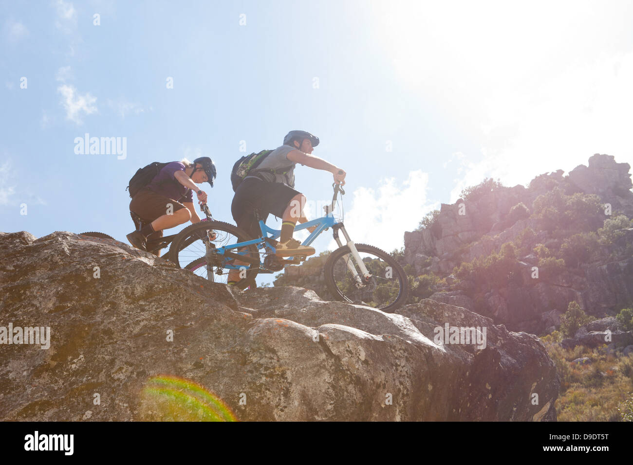 Young couple on mountain bikes on rocks Stock Photo - Alamy