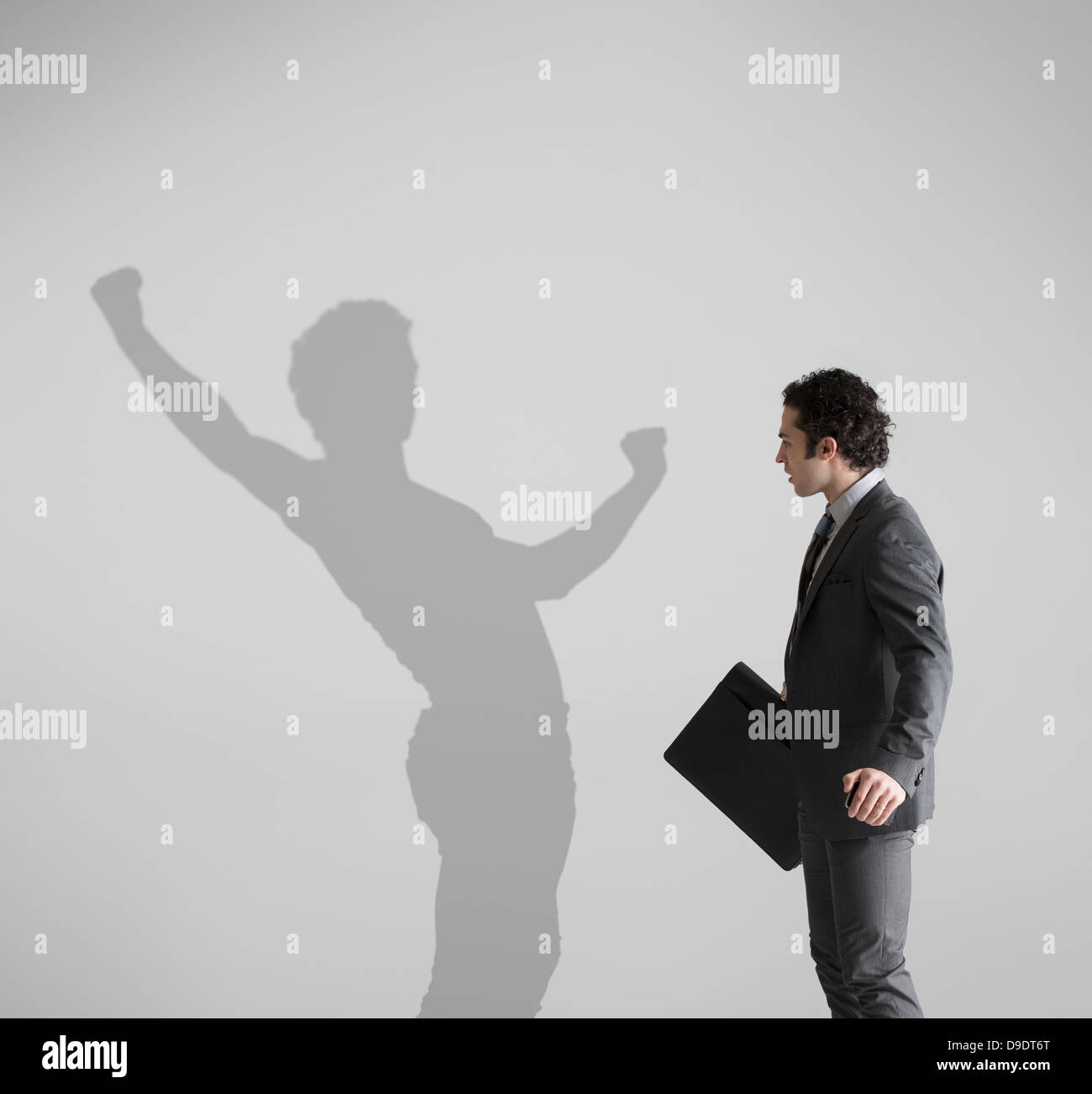 Shadow man holding briefcase hi-res stock photography and images - Alamy