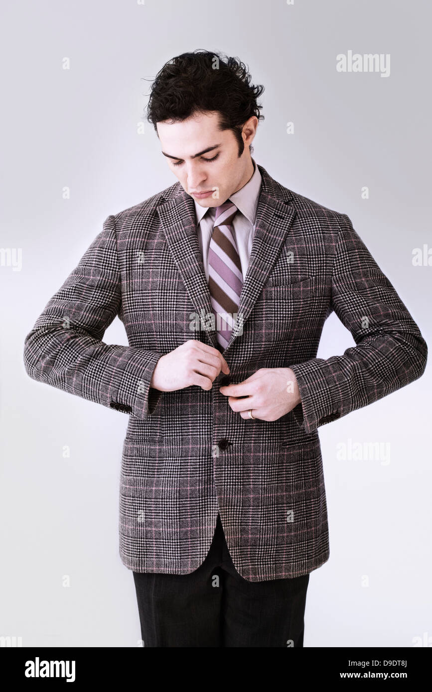 Man buttoning suit jacket Stock Photo - Alamy