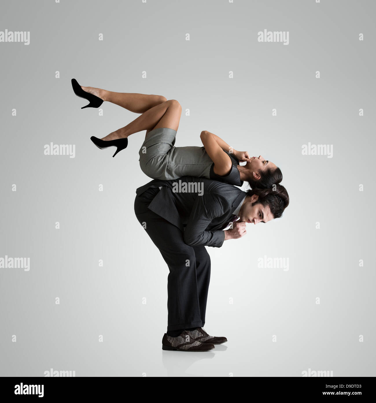 Woman lying on top of man's back Stock Photo - Alamy