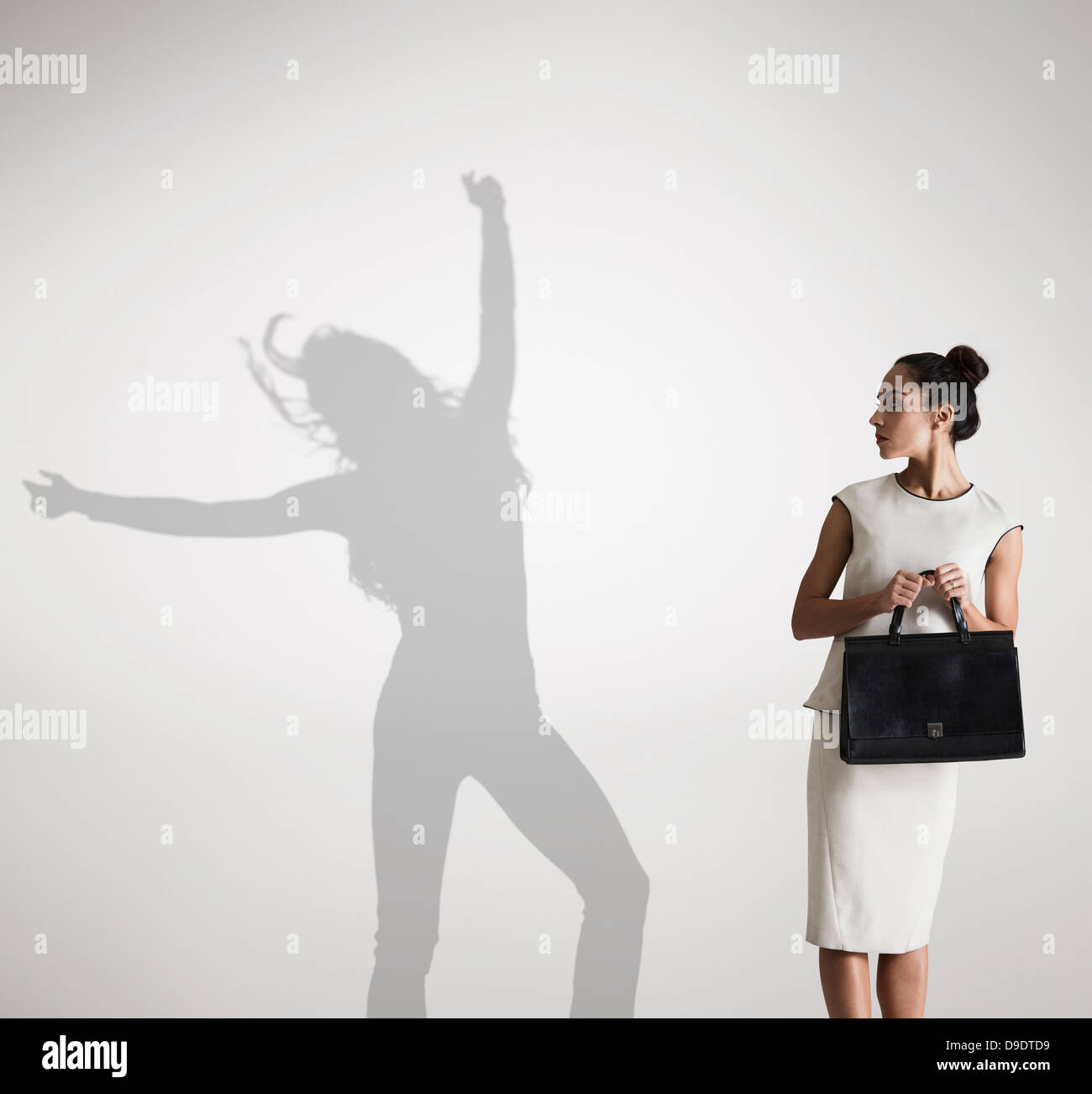 Woman with shadow in background dancing Stock Photo - Alamy