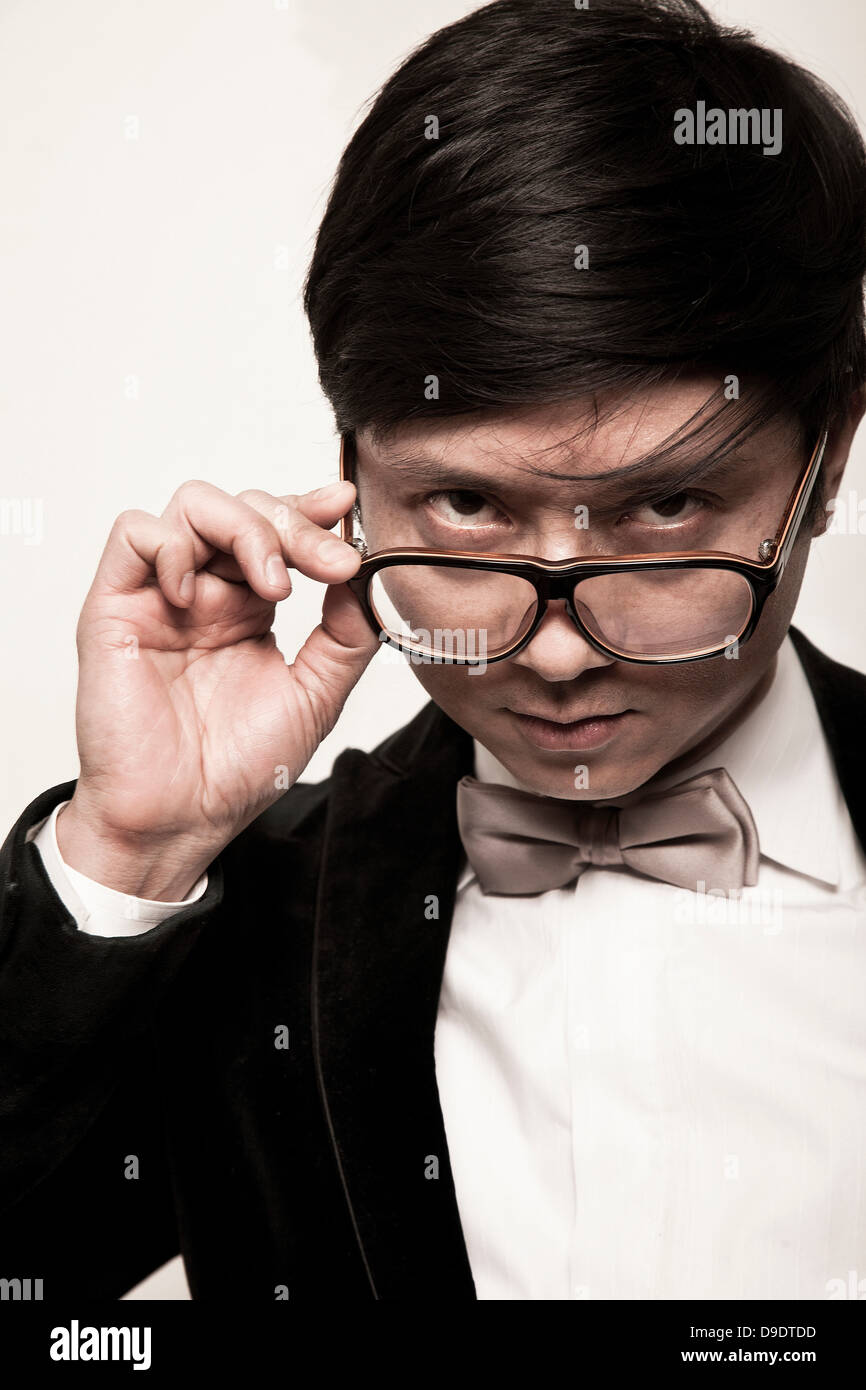 Portrait of man peering over glasses Stock Photo - Alamy