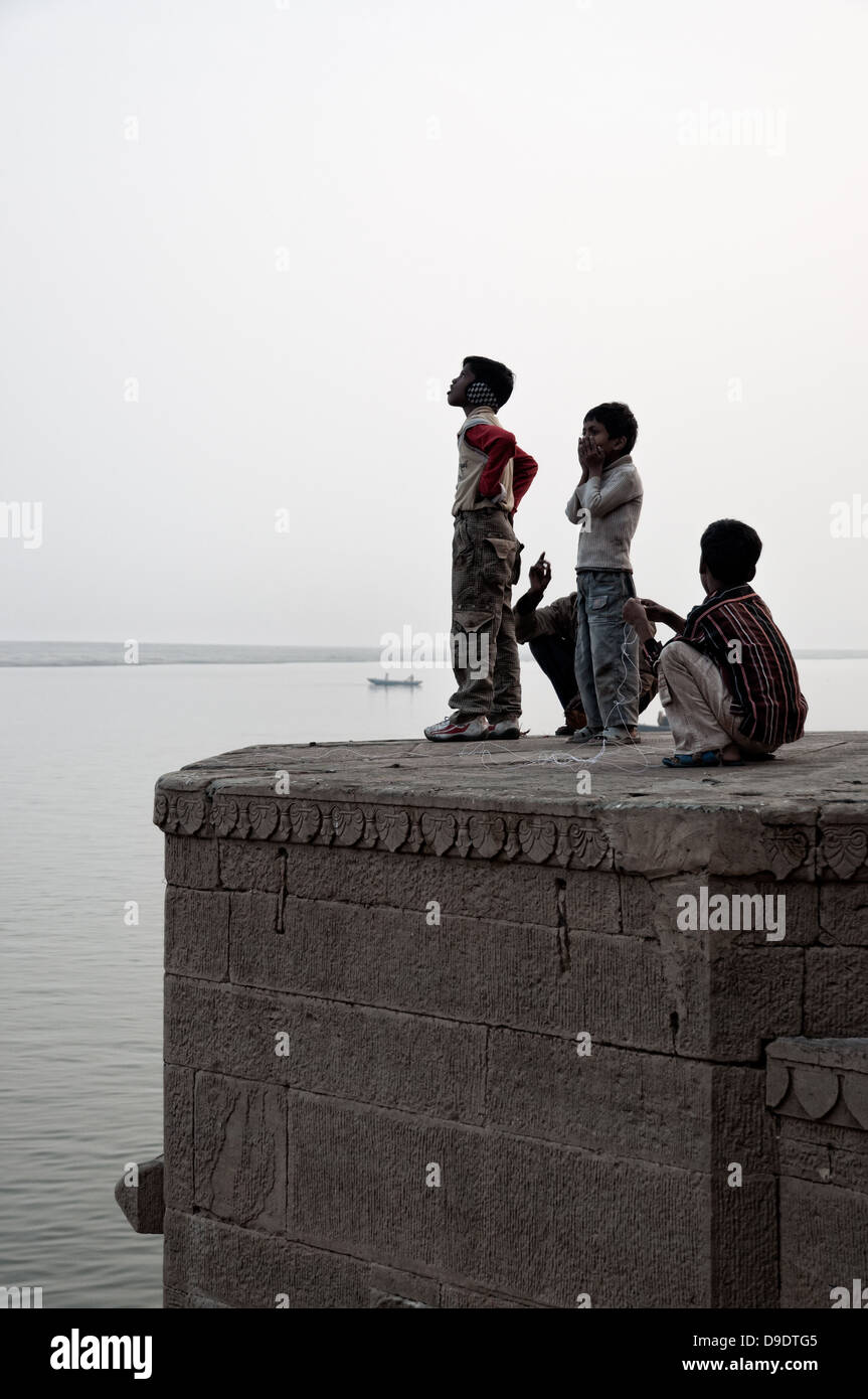 Children at the Ganges riverbanks in a misty morning. Varanasi, Benares ...