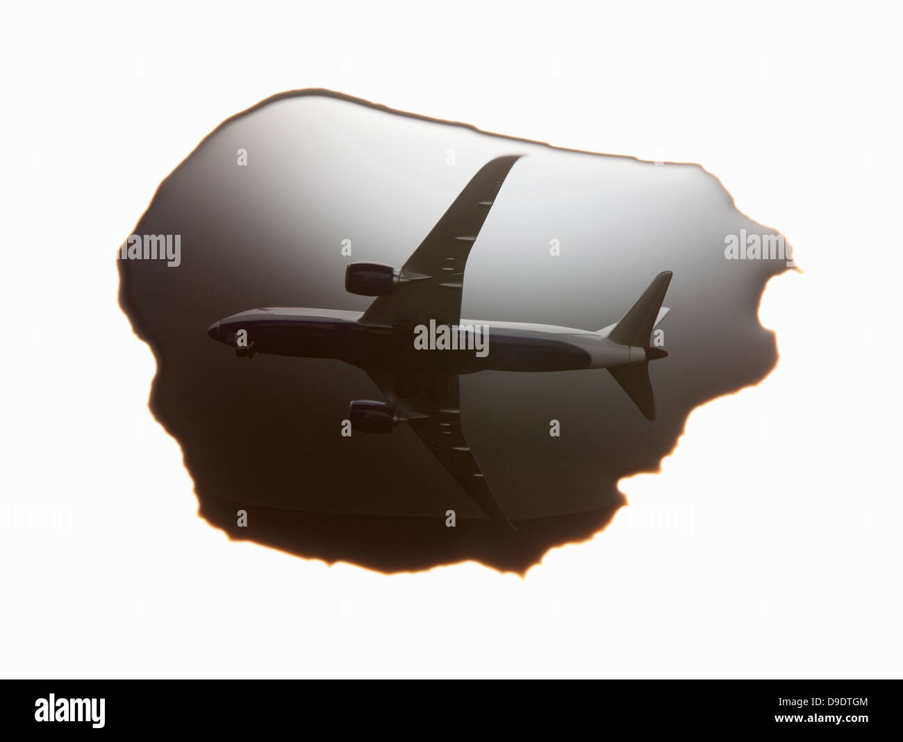 Airplane reflected in pool of oil Stock Photo - Alamy