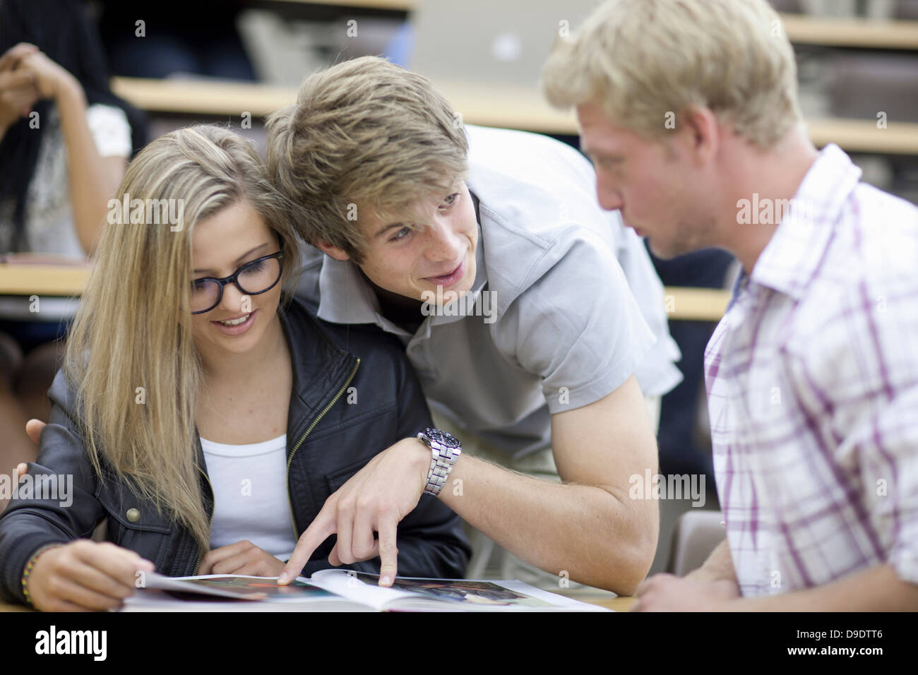 Three students talking Stock Photo - Alamy