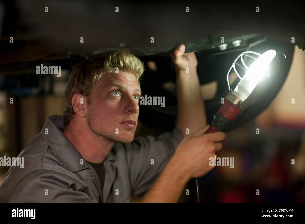 Car mechanic at work in service bay Stock Photo - Alamy