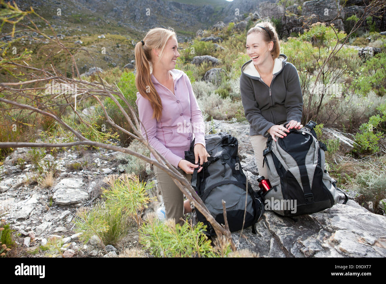 Portrait of two young female hikers with rucksacks Stock Photo - Alamy