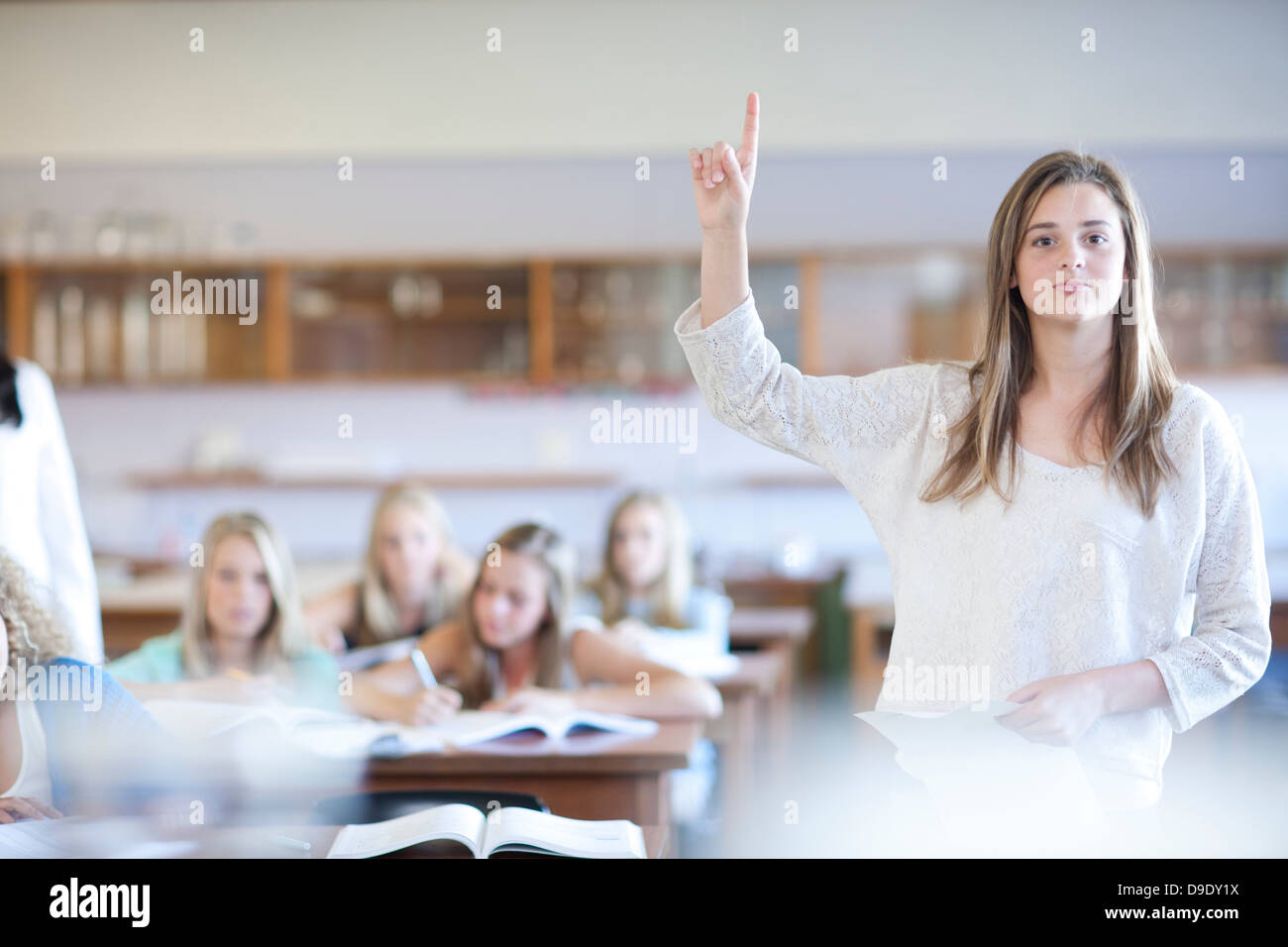 Girl standing up desk classroom hi-res stock photography and images - Alamy