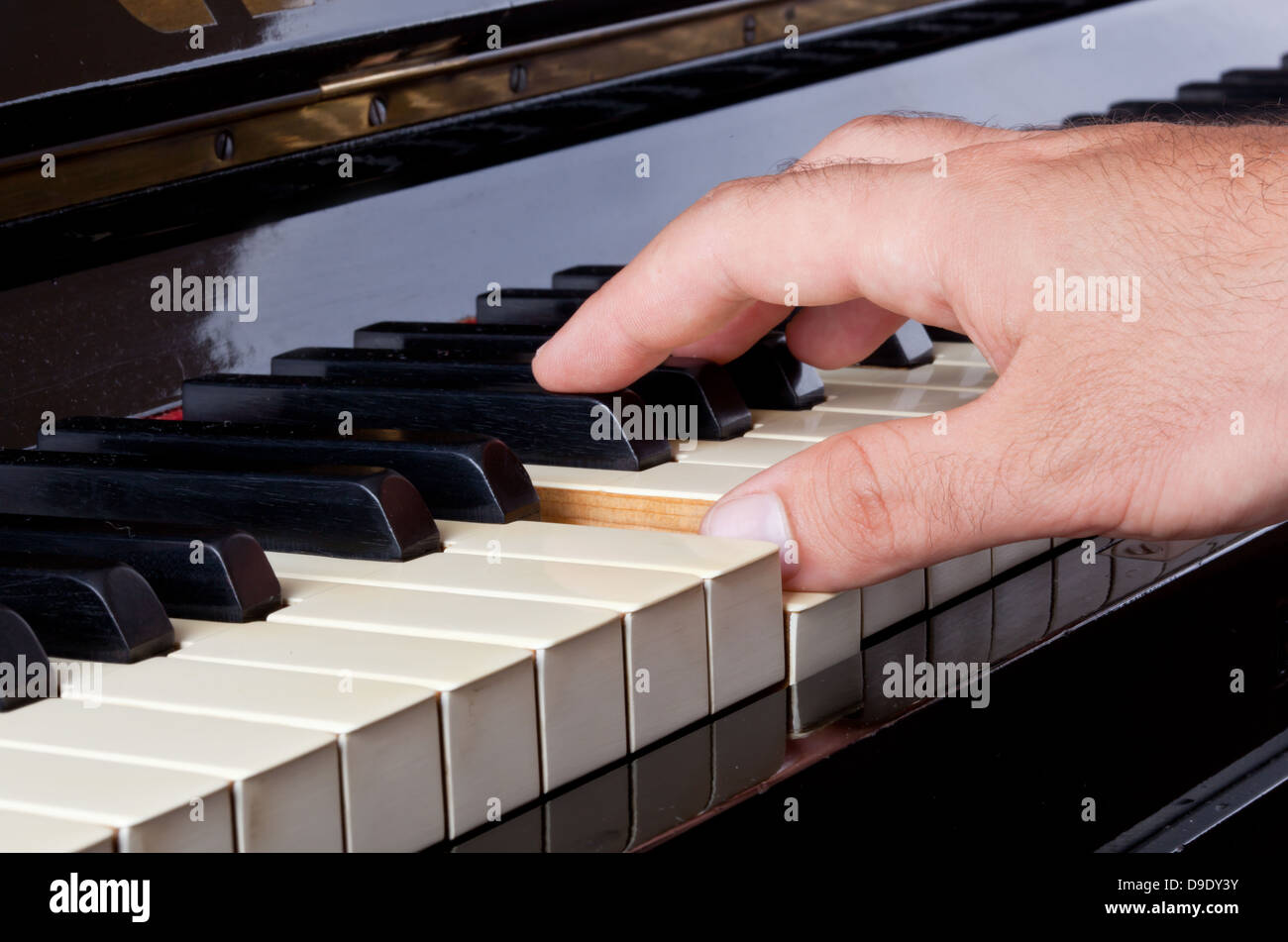 Piano keyboard made of ivory with hands Stock Photo - Alamy