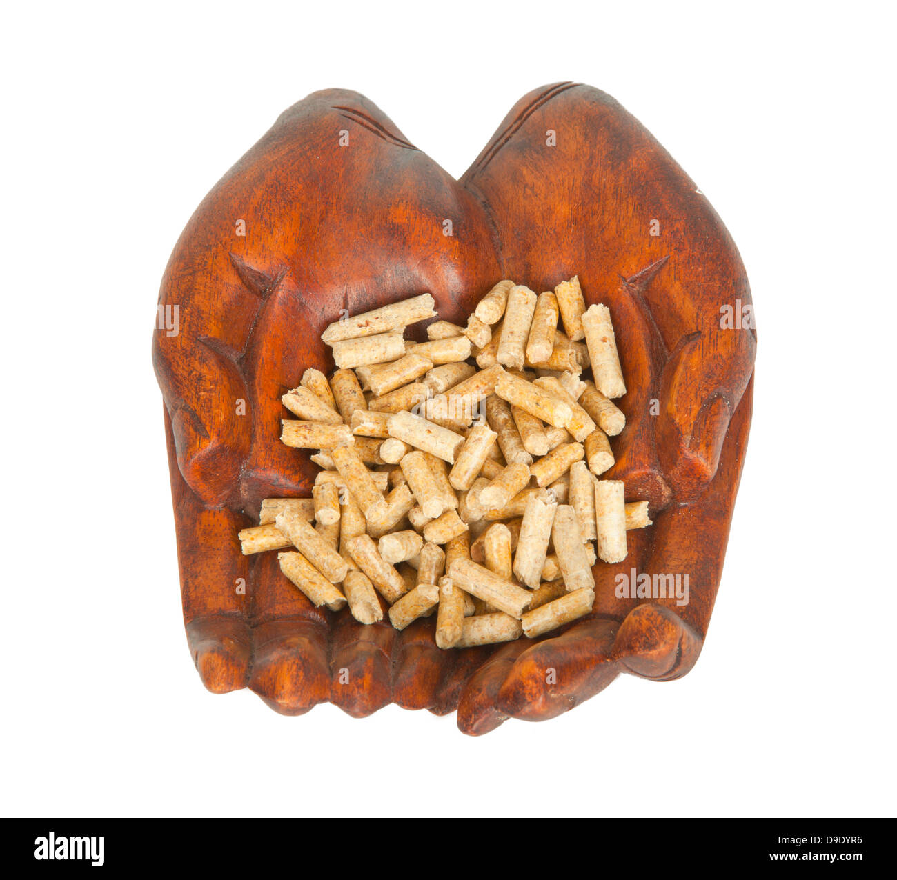 Wood pellets in hand on white background Stock Photo - Alamy