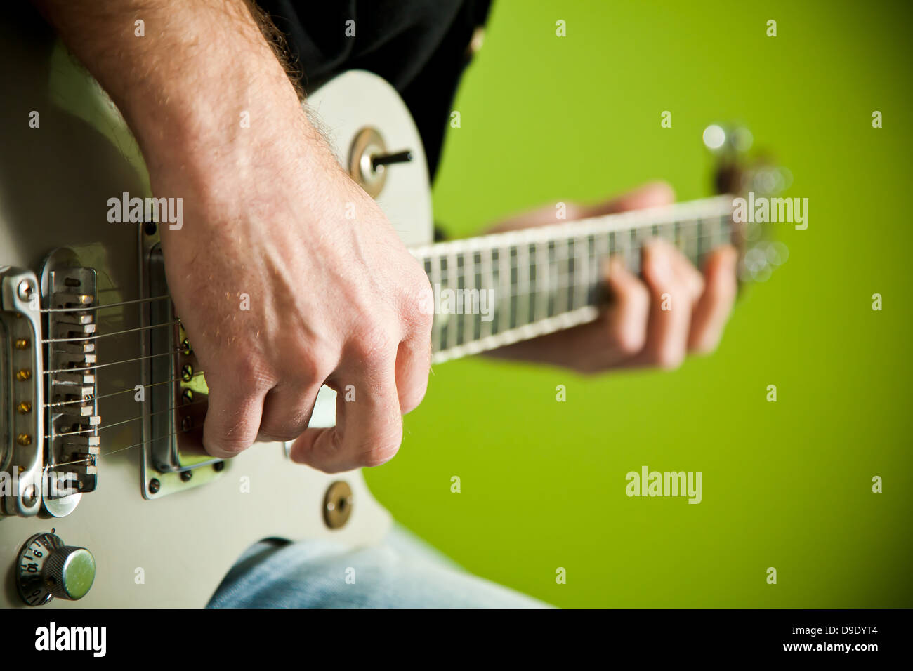 Close up of an electric guitar being played Stock Photo - Alamy
