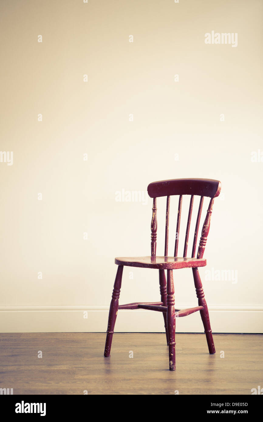 A single wooden chair placed in an empty room Stock Photo - Alamy