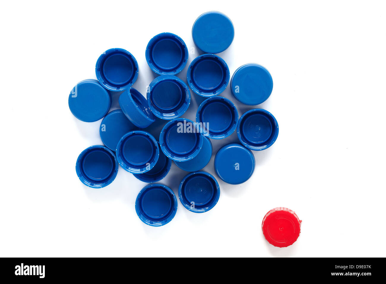 Group of blue plastic caps and one red Stock Photo - Alamy