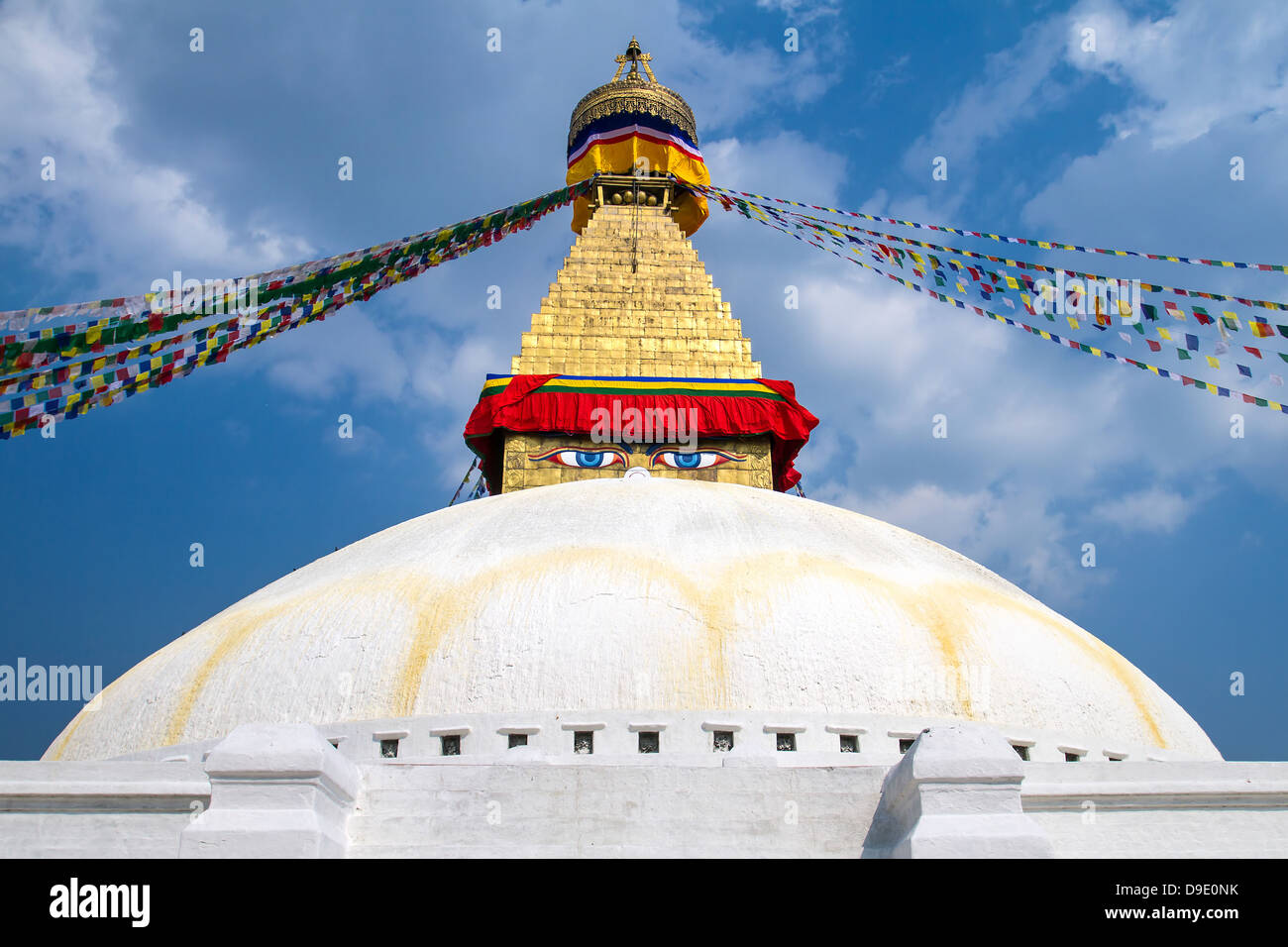Buddhist shrine Boudhanath Stupa with Buddha wisdom eyes and praying ...