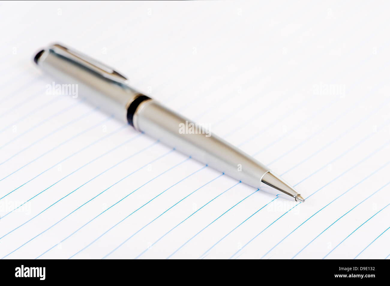 a stylish silver pen photographed on lined paper Stock Photo - Alamy