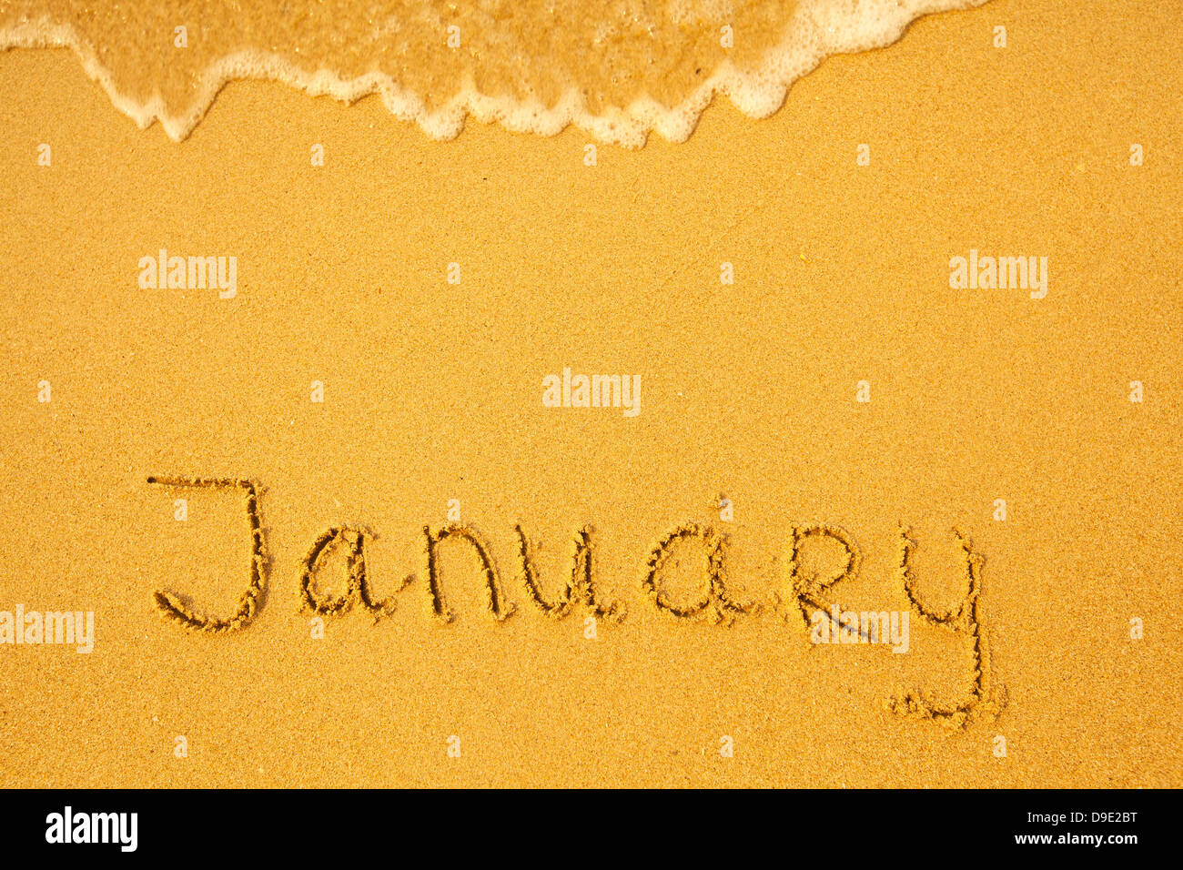 January- written in sand on beach texture Stock Photo - Alamy