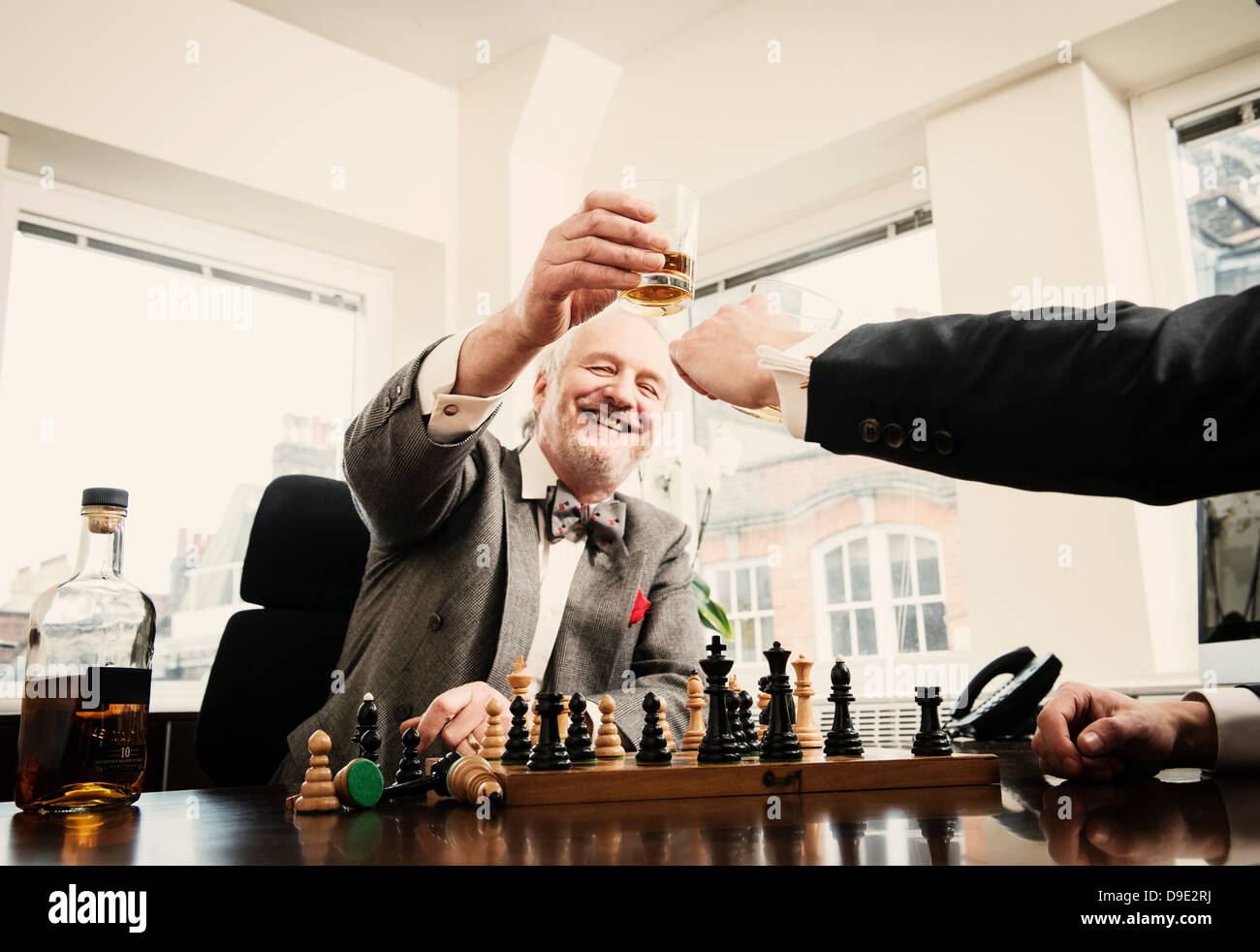 Two men playing chess in office Stock Photo - Alamy