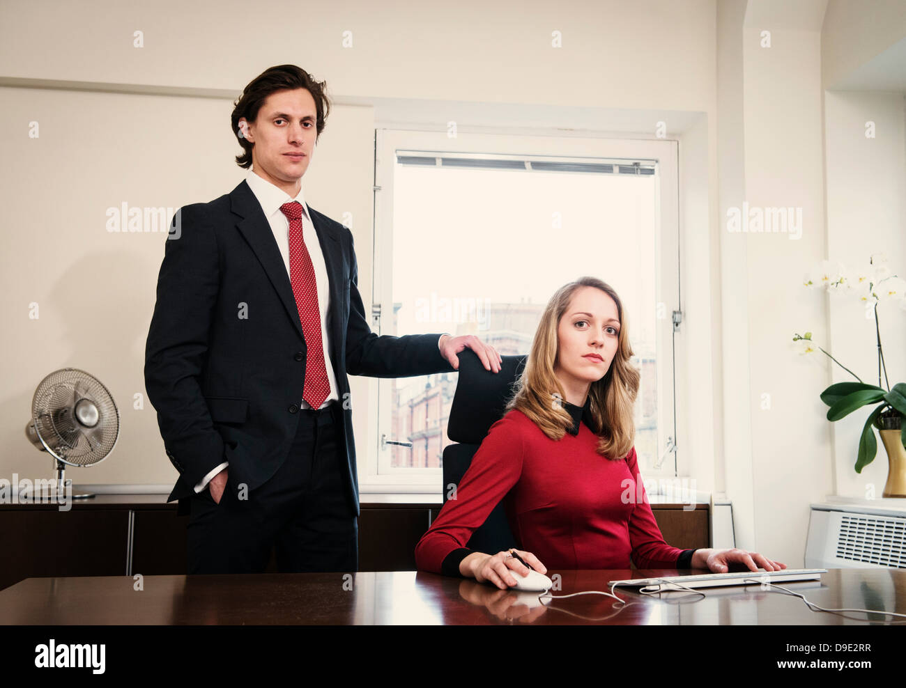 Female manager at desk with male colleague Stock Photo - Alamy
