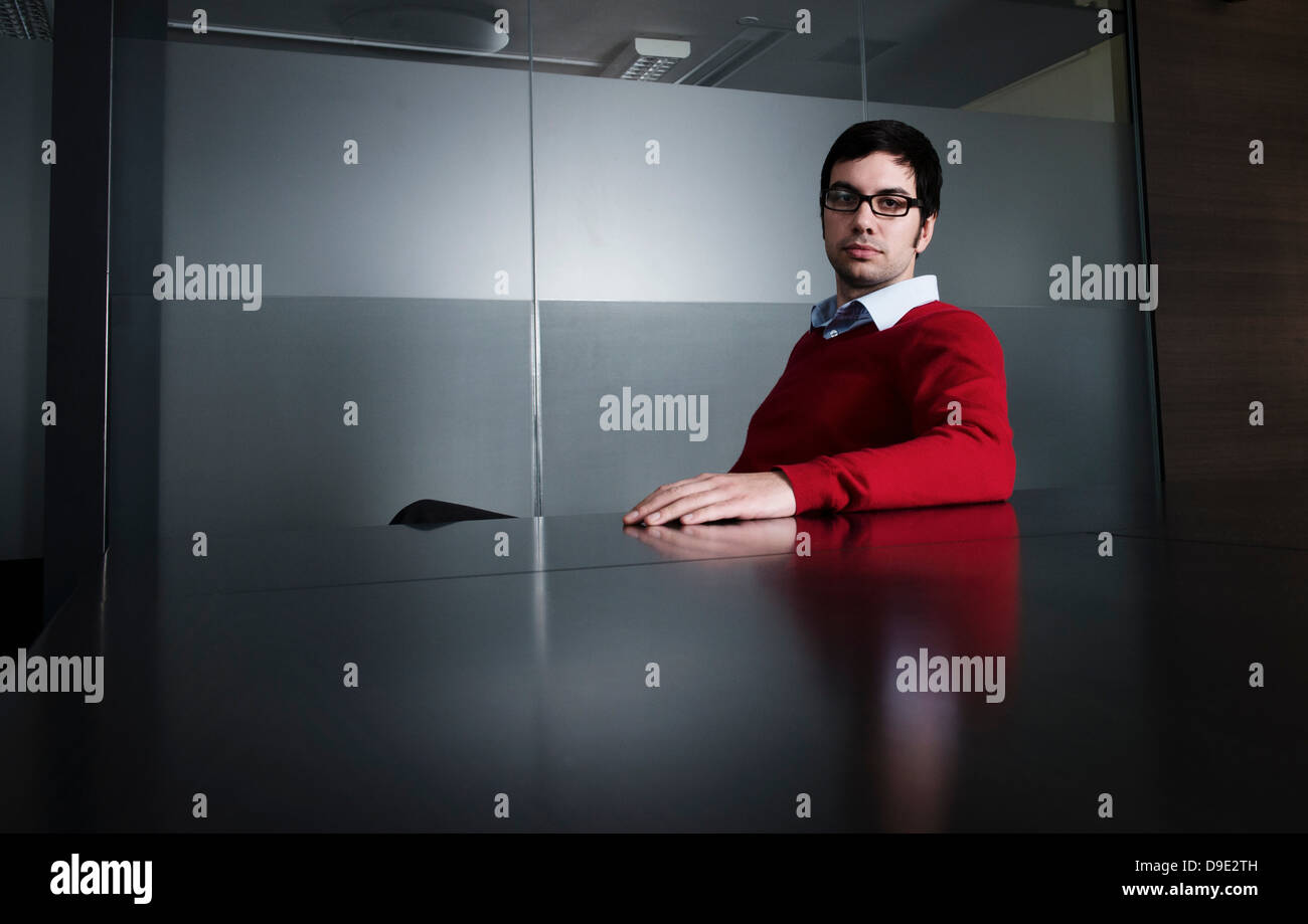 Business executive looking bored at meeting table Stock Photo - Alamy