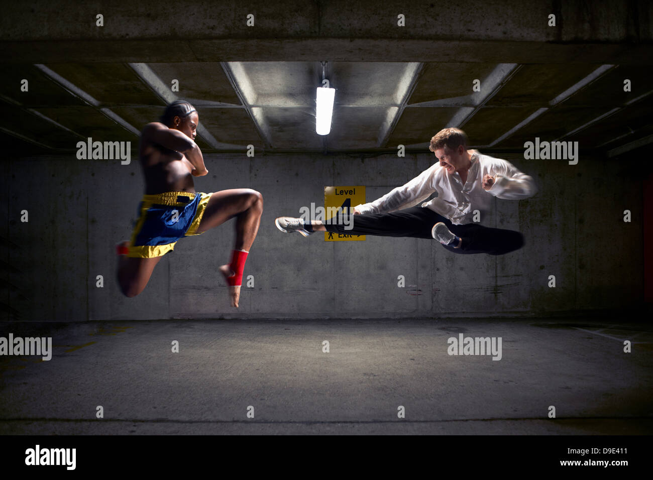 Boxer and kick boxer mid air in parking lot Stock Photo - Alamy