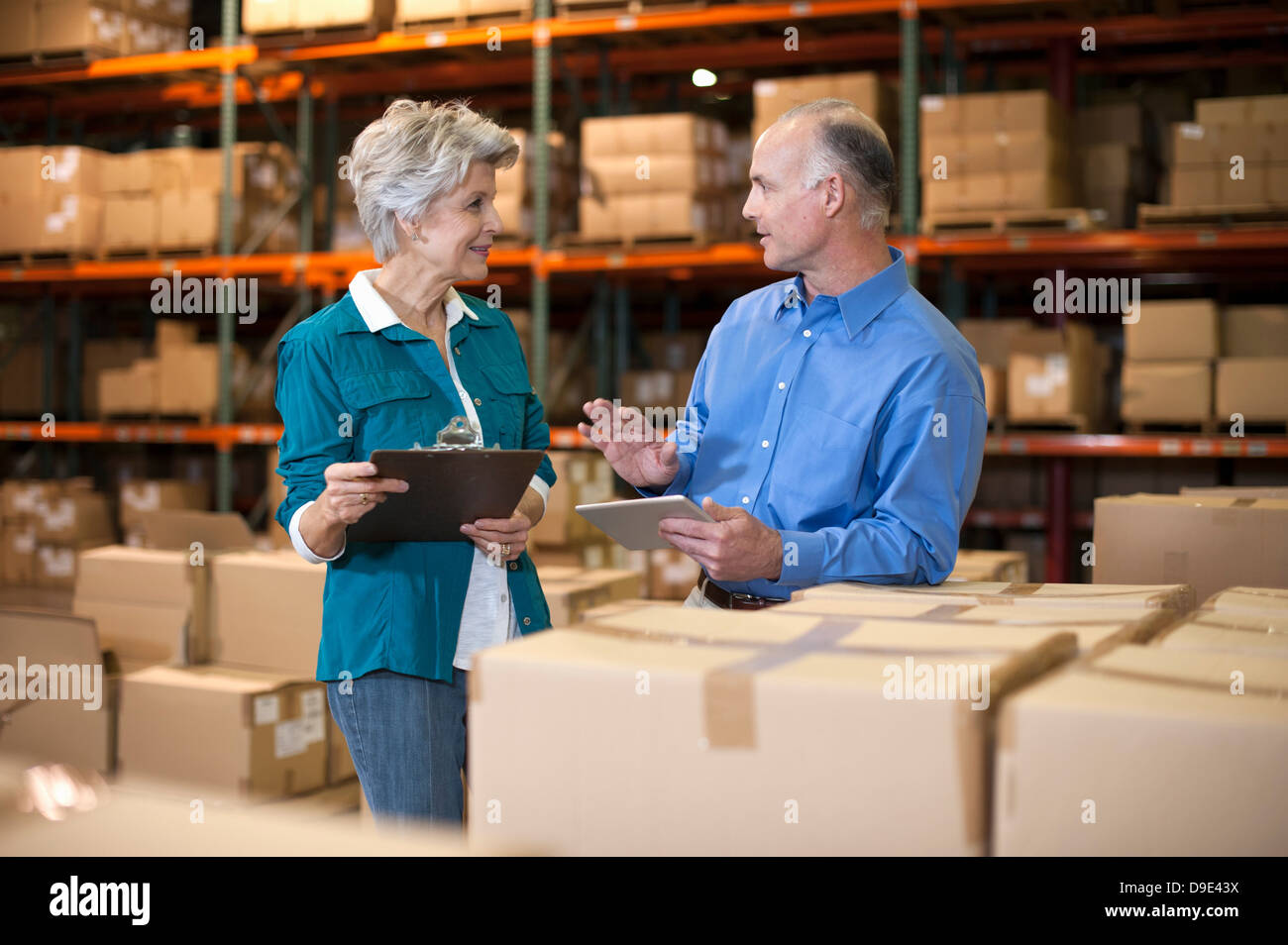 Warehouse workers using digital tablet Stock Photo - Alamy